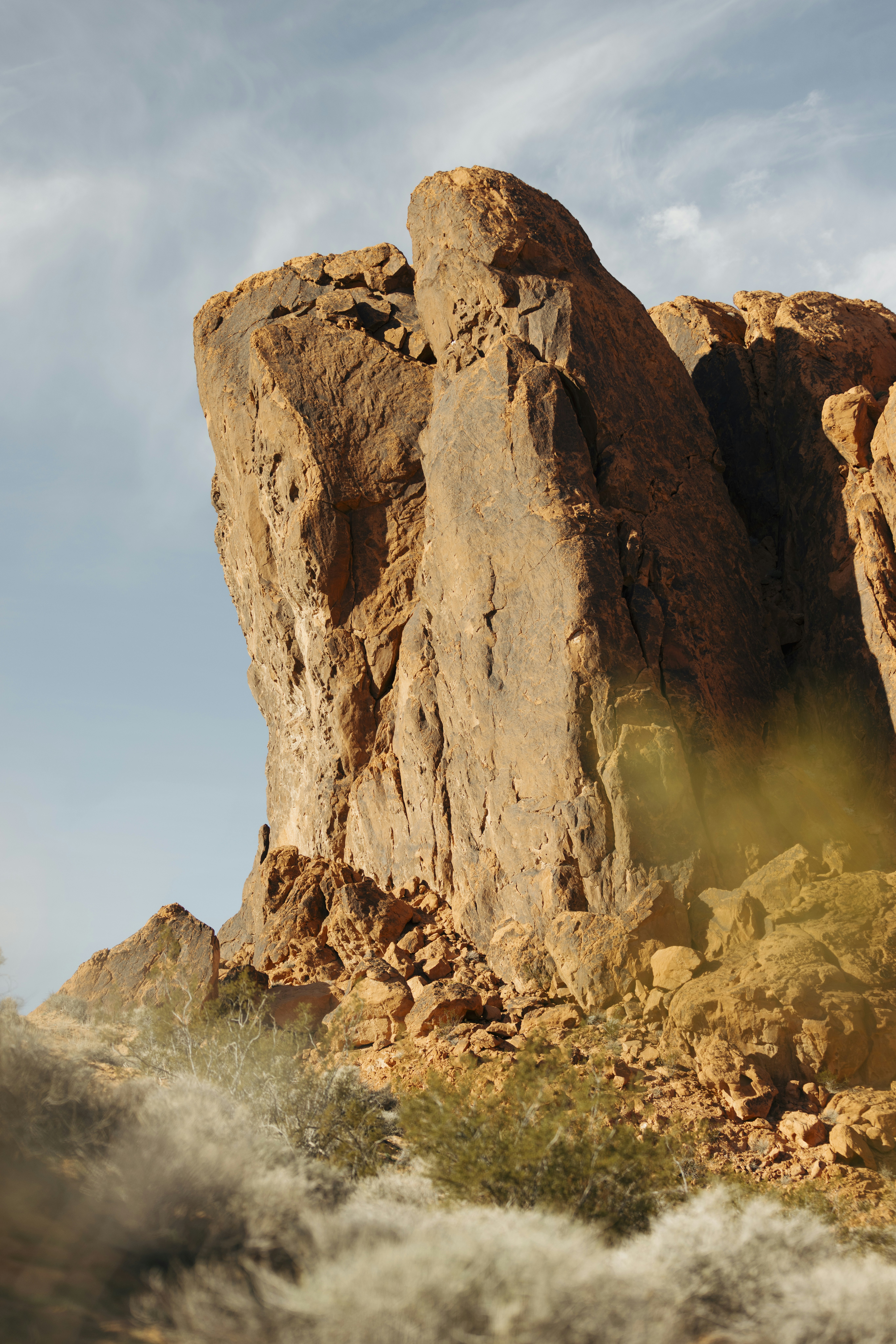 Desert Sentinel: Weathered rock formation under a pale blue sky