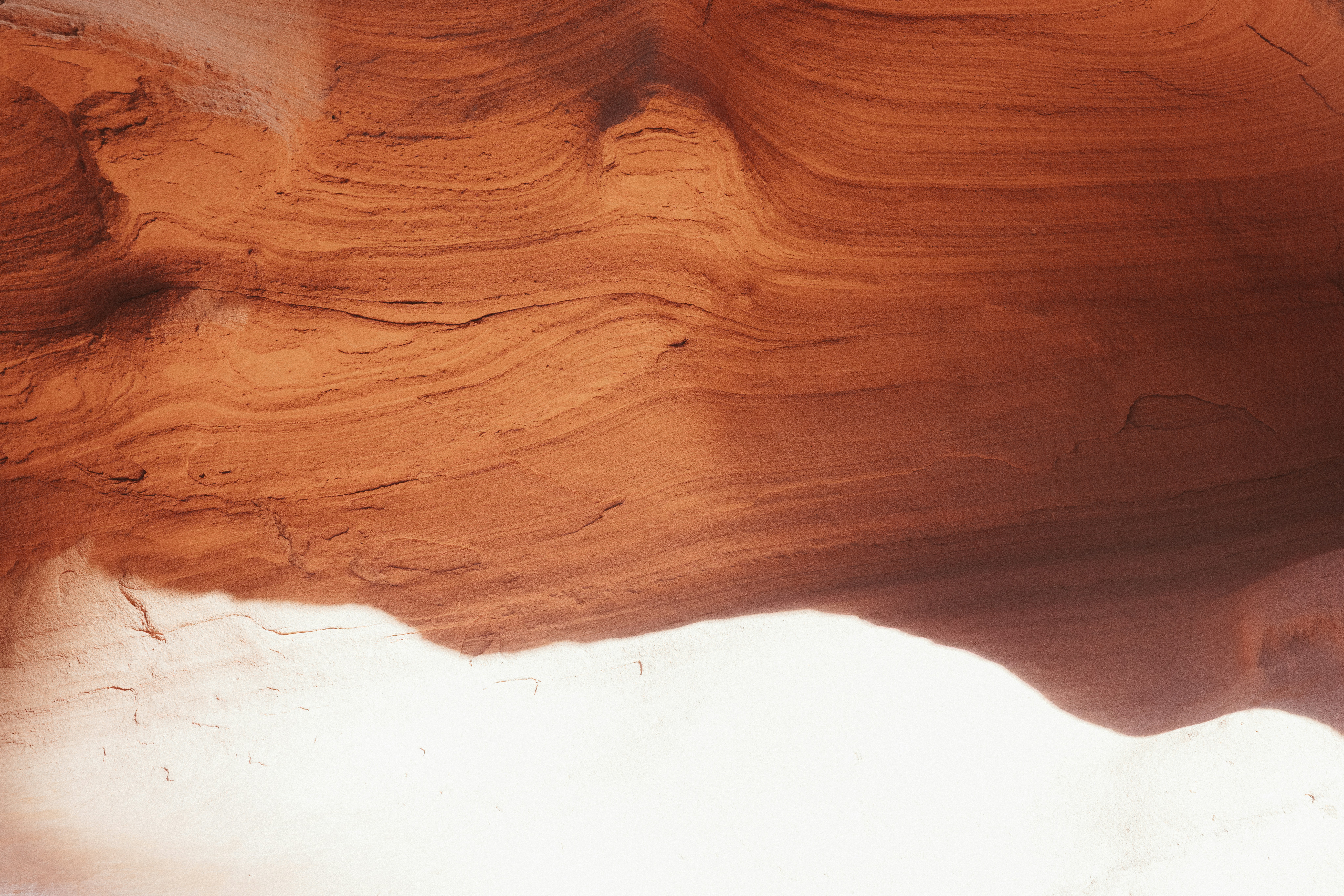 Curved Terracotta Strata Adrift in Bright Light