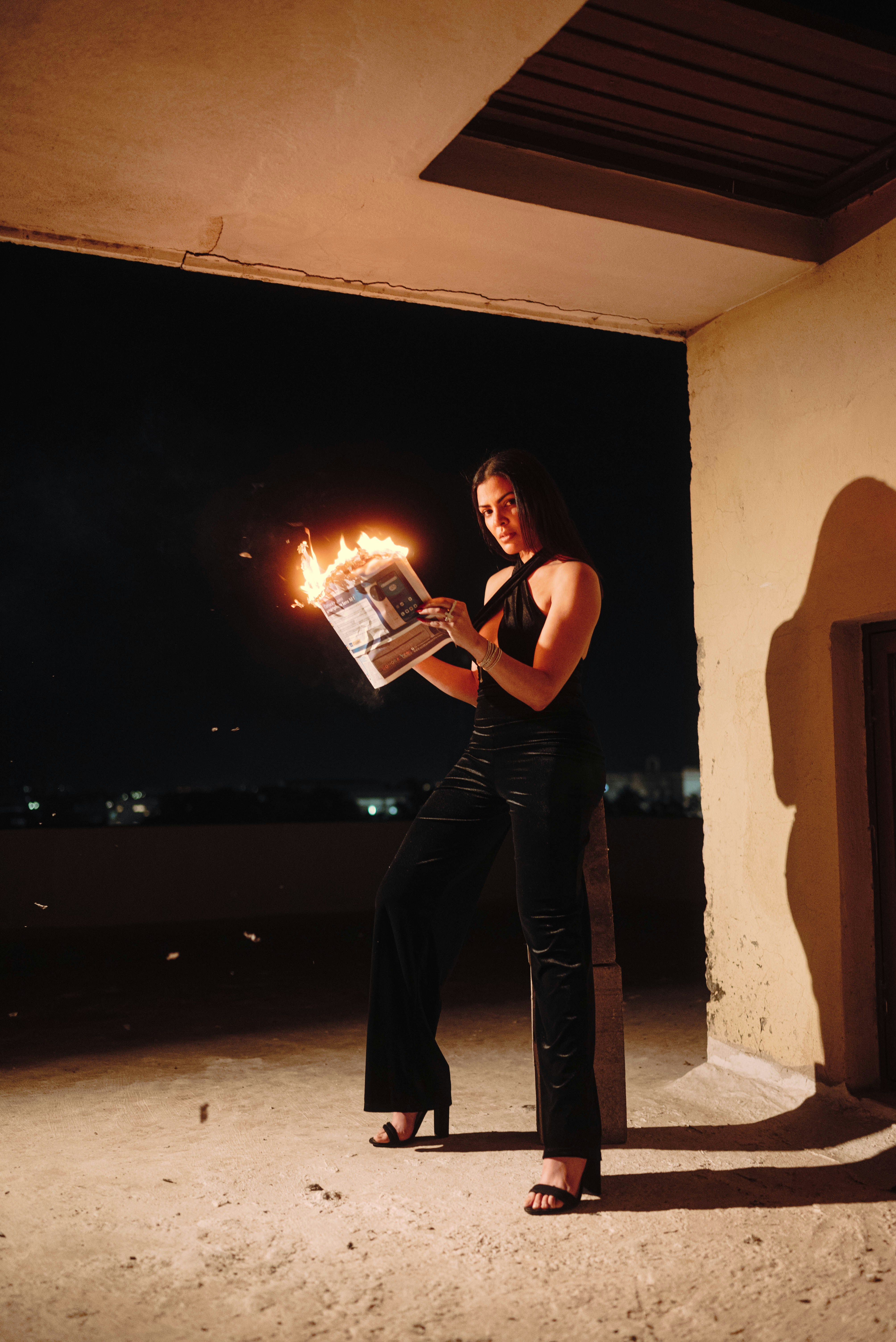 Flamelit Portrait on a Rooftop: Reading Firelight
