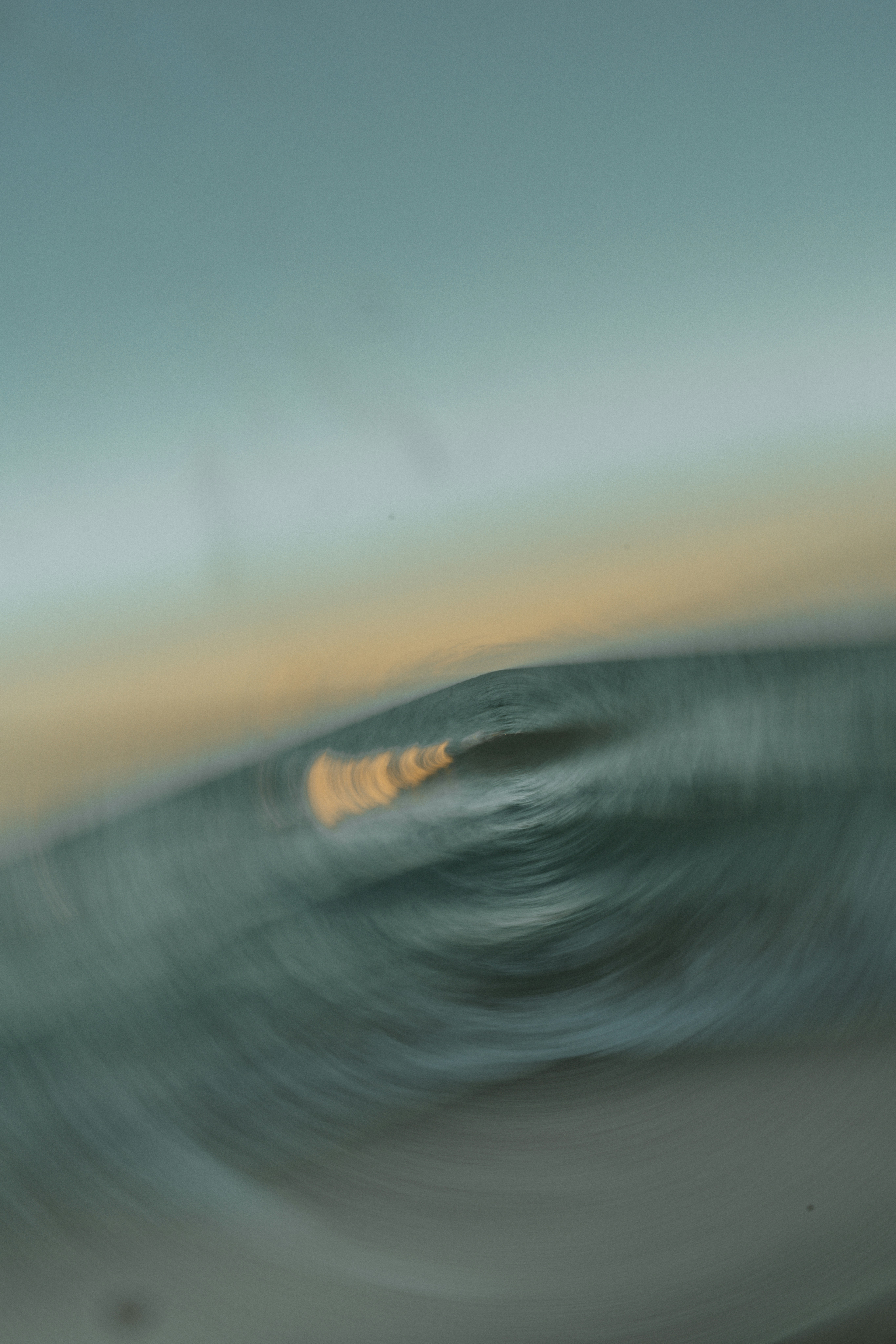 Spiral Wave: A Water Surface in Soft Sunset Blur