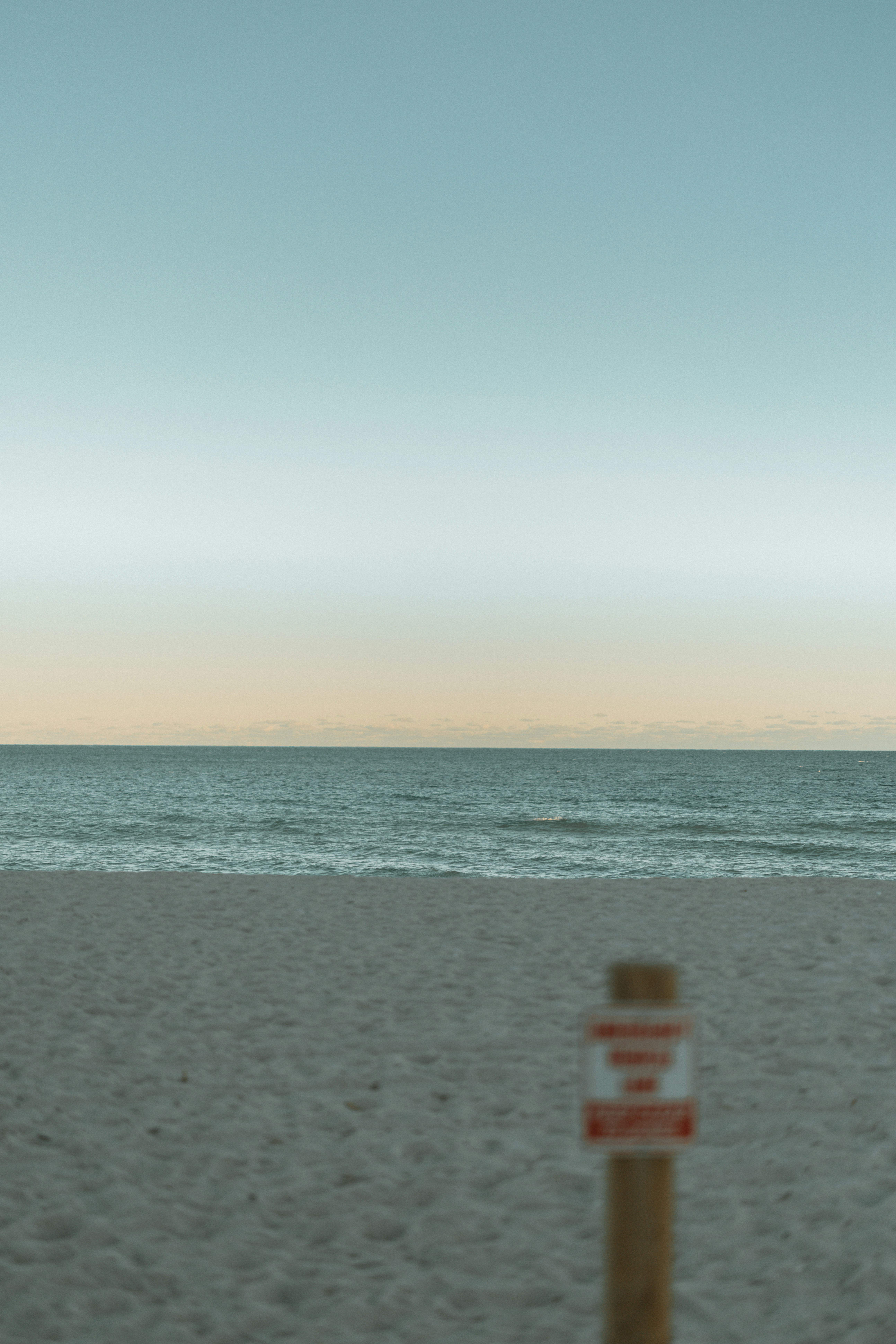 Quiet Shoreline Signpost at Dusk