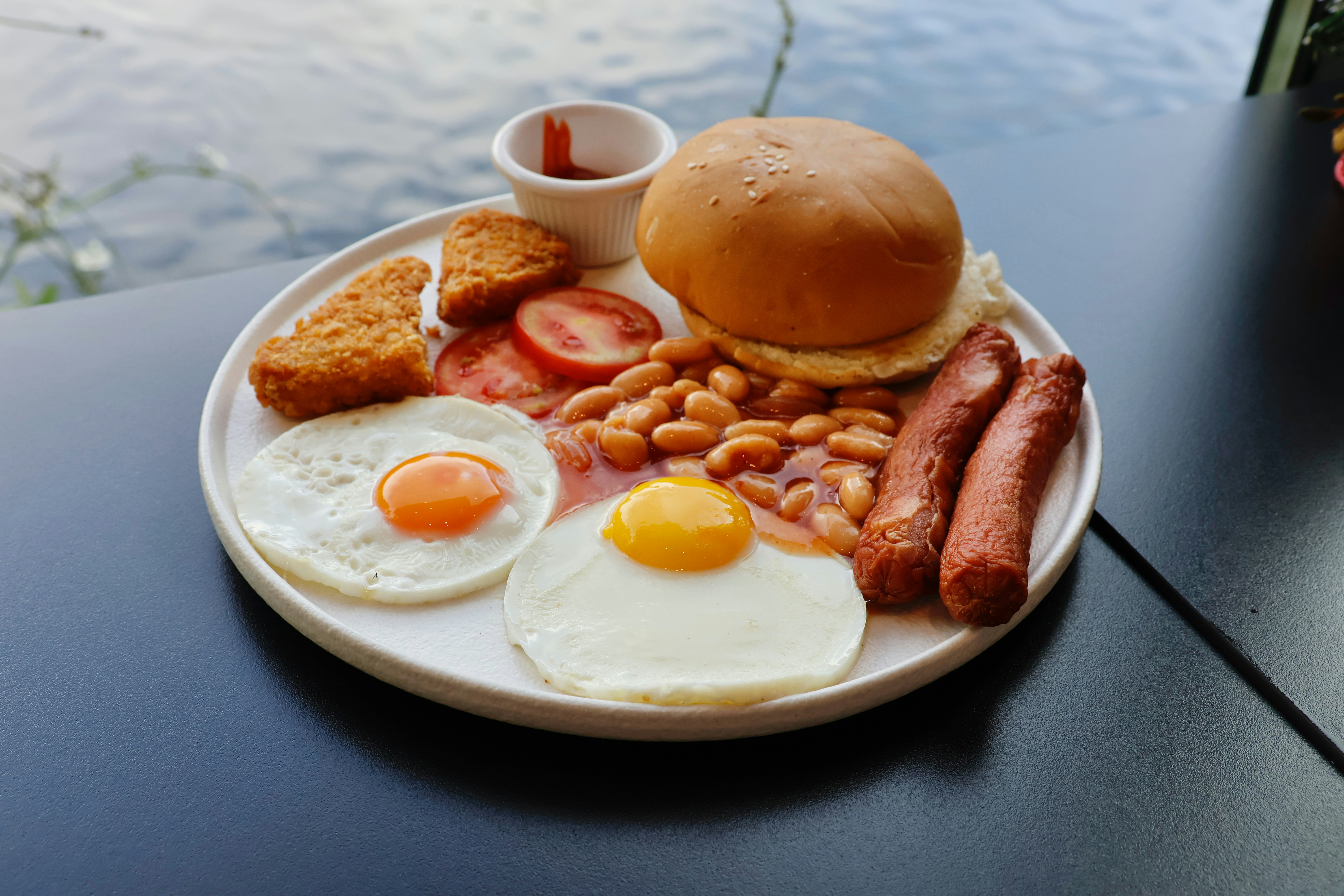 Sunlit Morning Plate: Eggs, Sausage, and Beans on a Parkside Table
