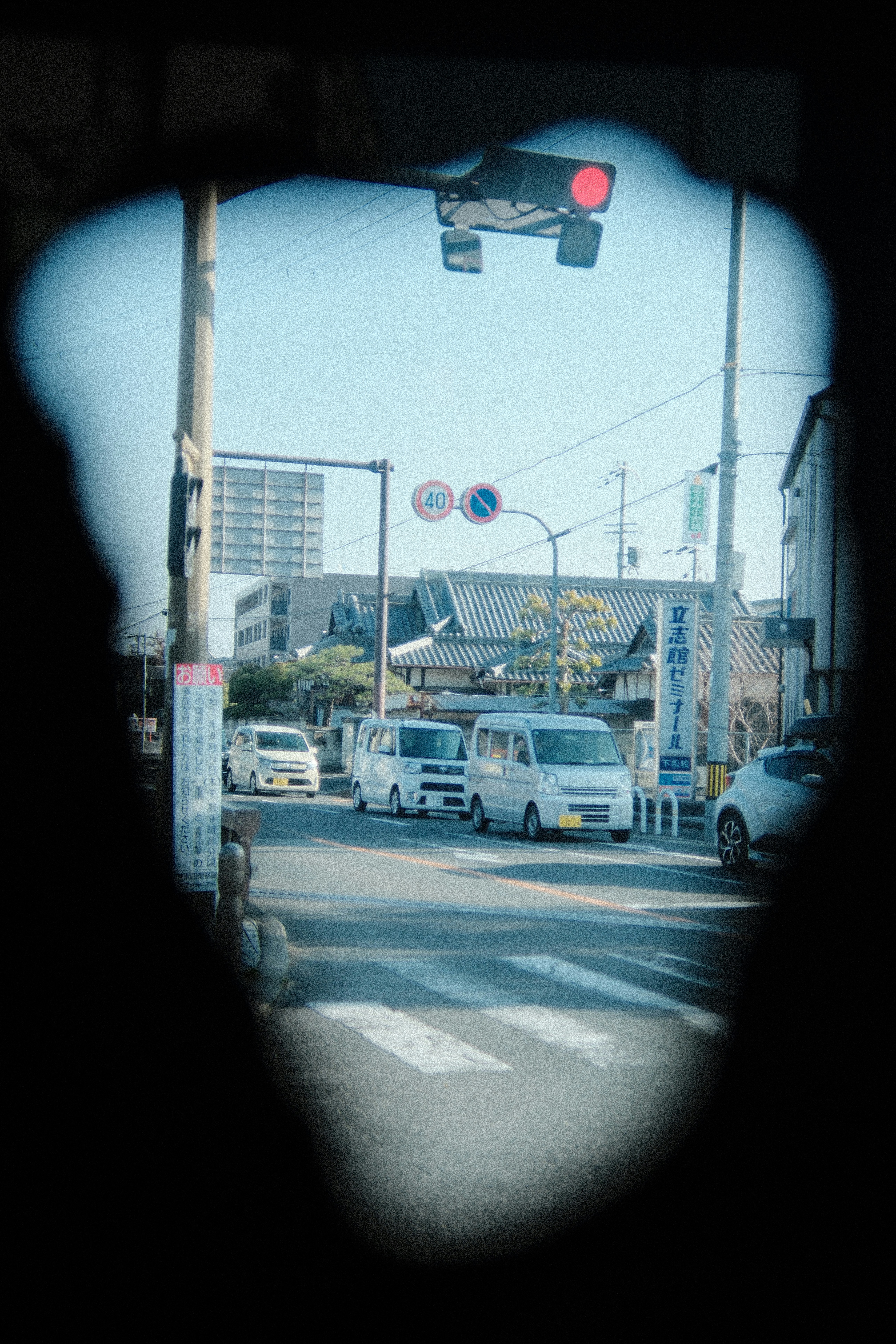 Through a Pedestrian Gate: Street Scene Framed by a Portal of Darkness