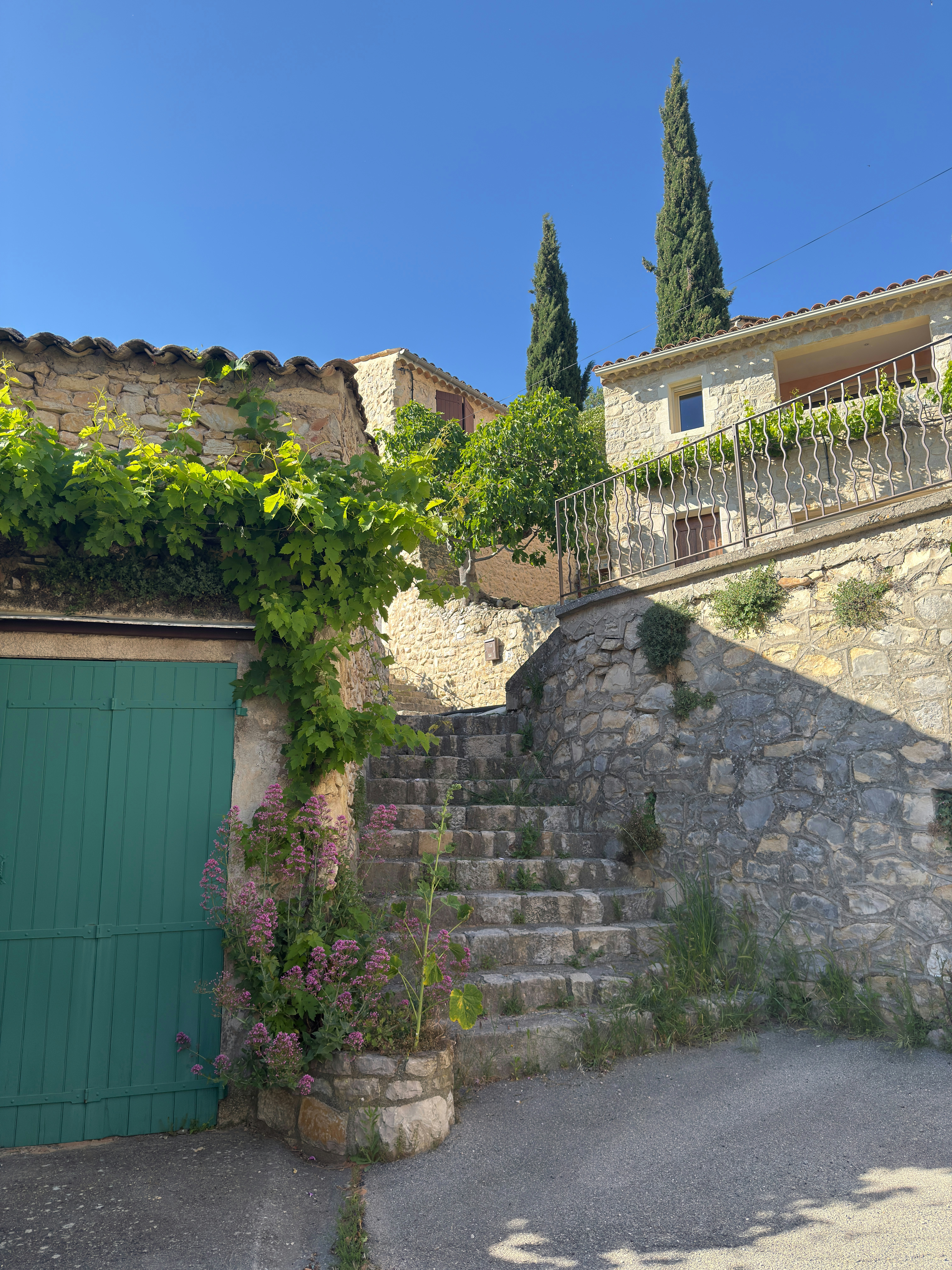 Stone staircase to sunlit village balcony