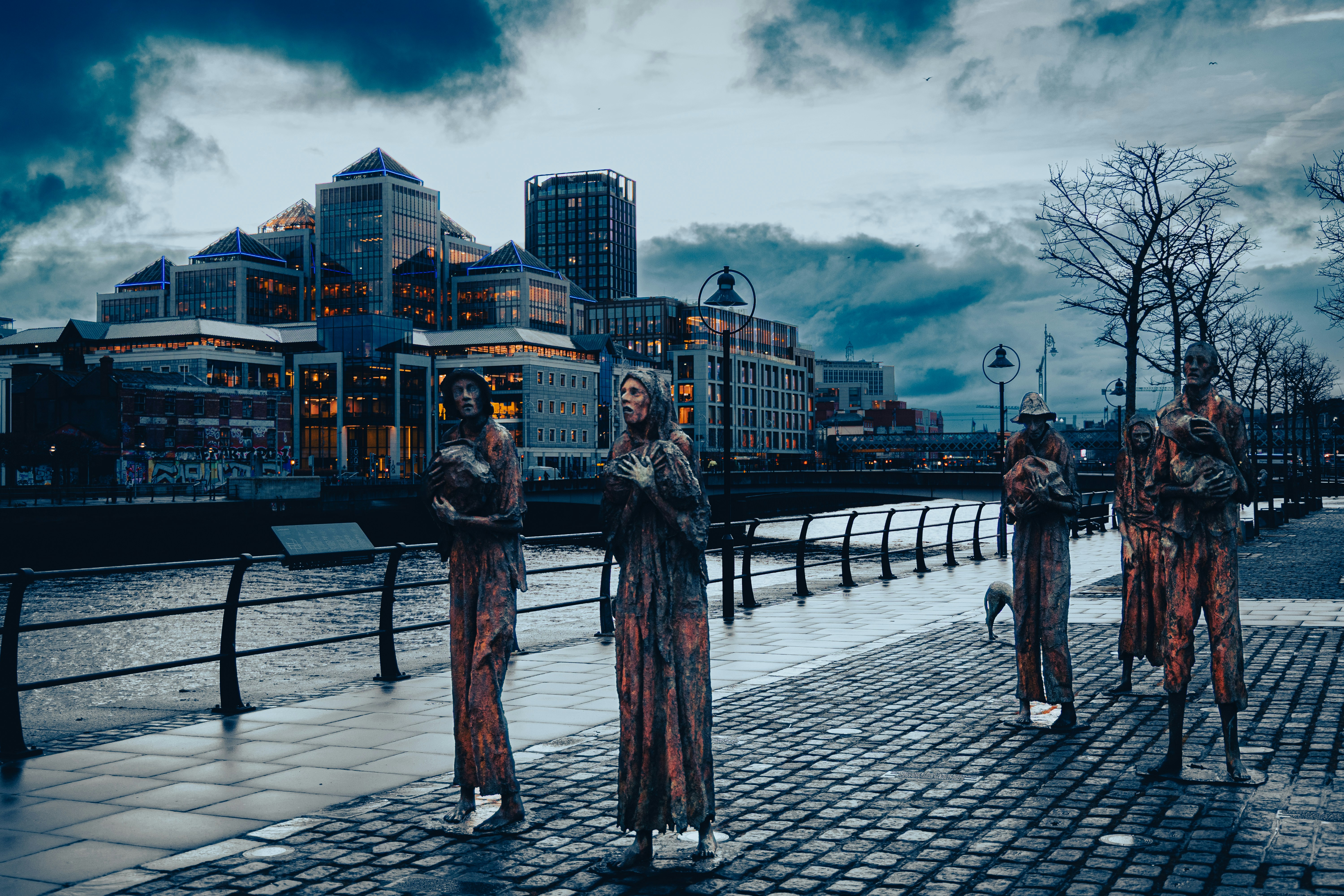 Urban Echoes: Robed Figures Along the Riverfront