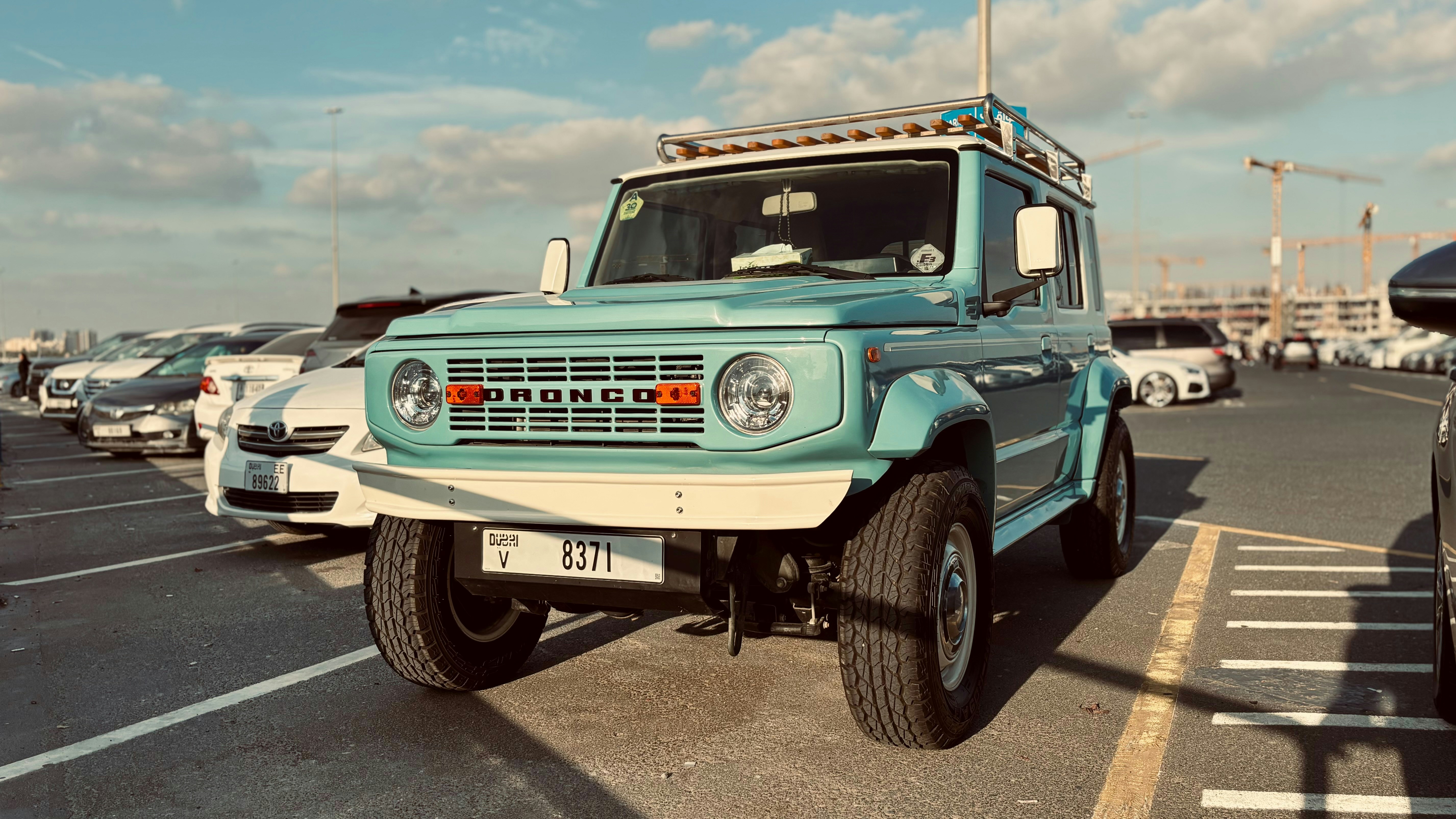 Thunder in the Lot: a turquoise off-roader standing tall