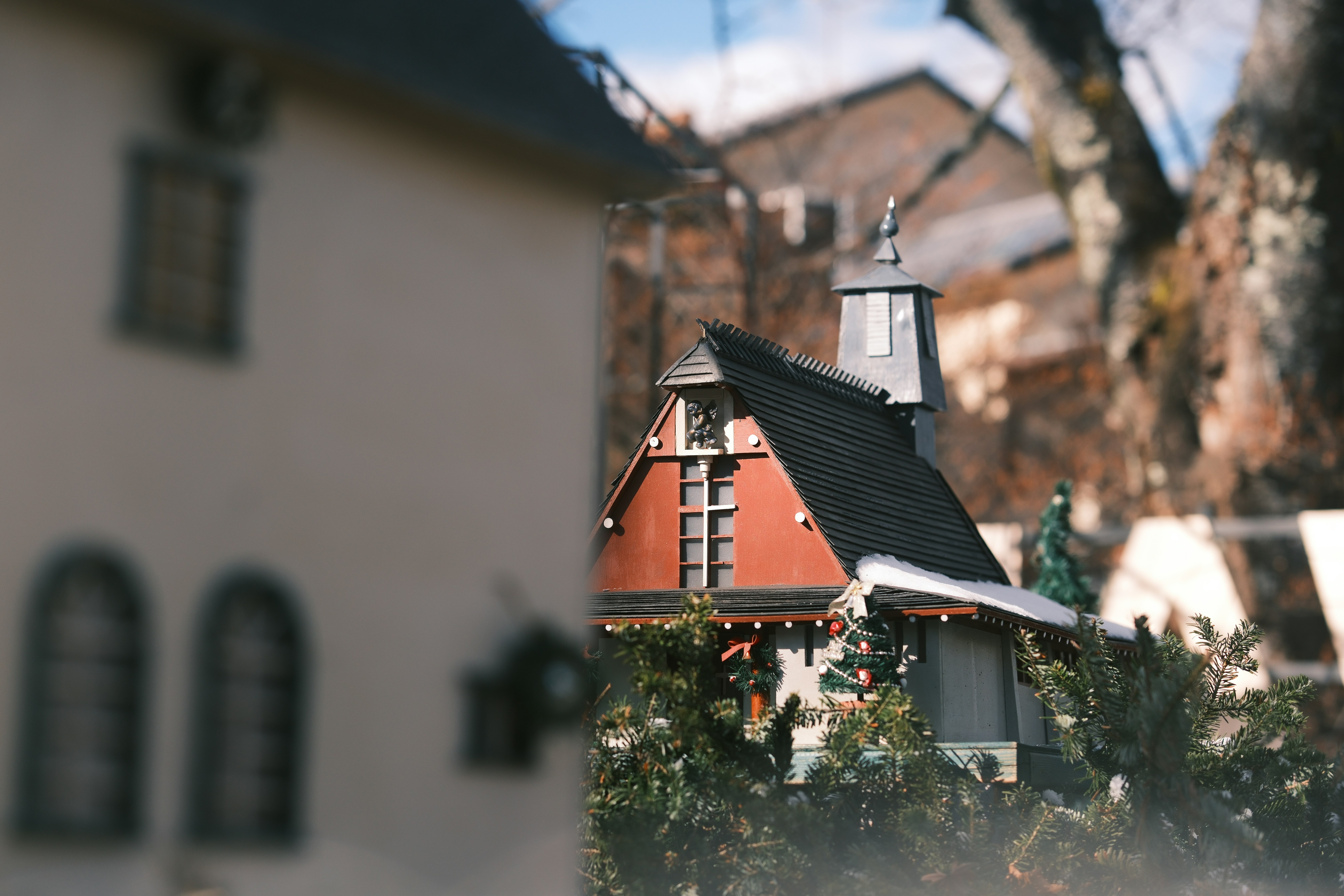 Miniature Chalet Amid Winter Greens