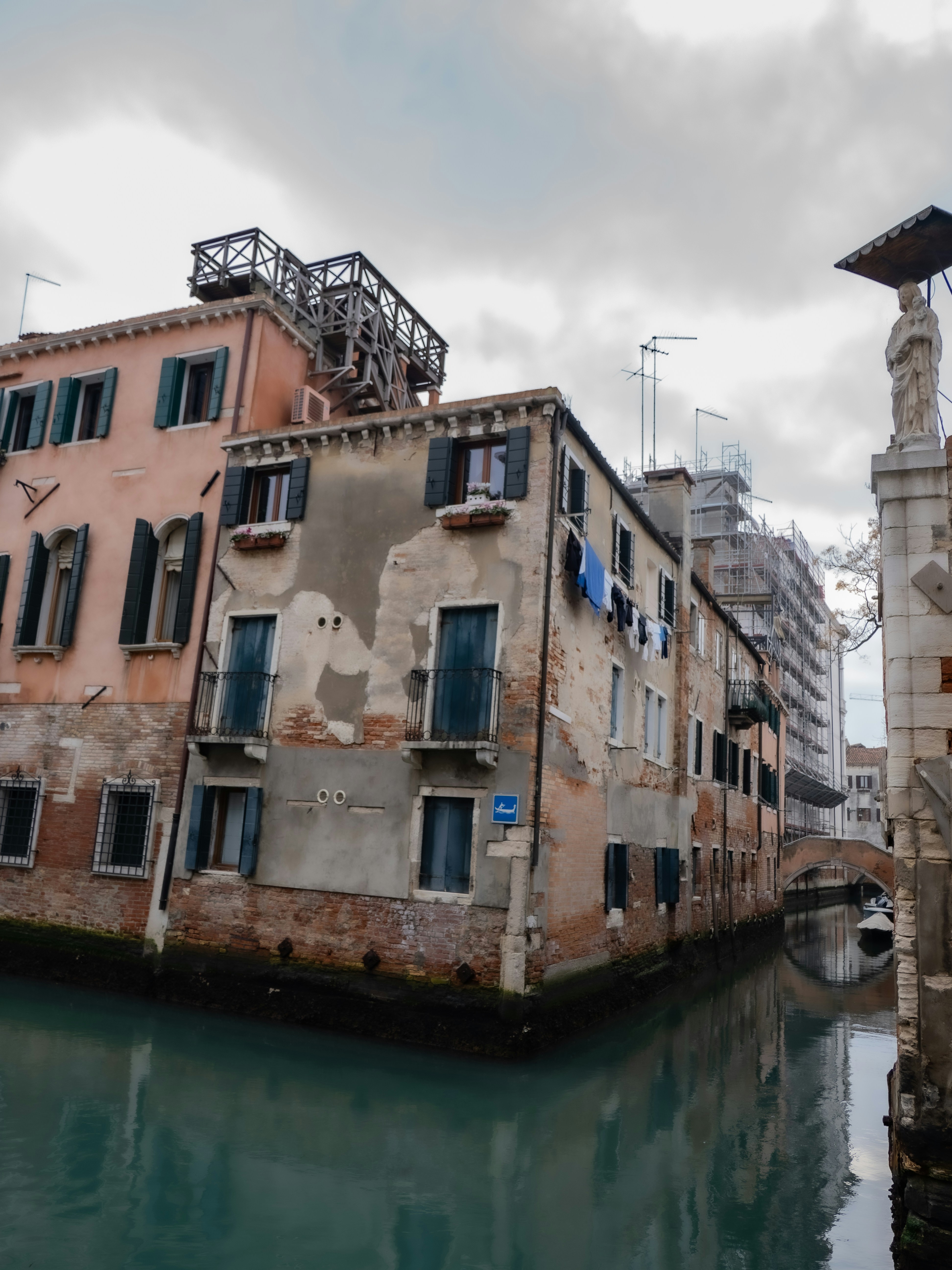 Canal Corner: Weathered Facades and a Bridge of Arches