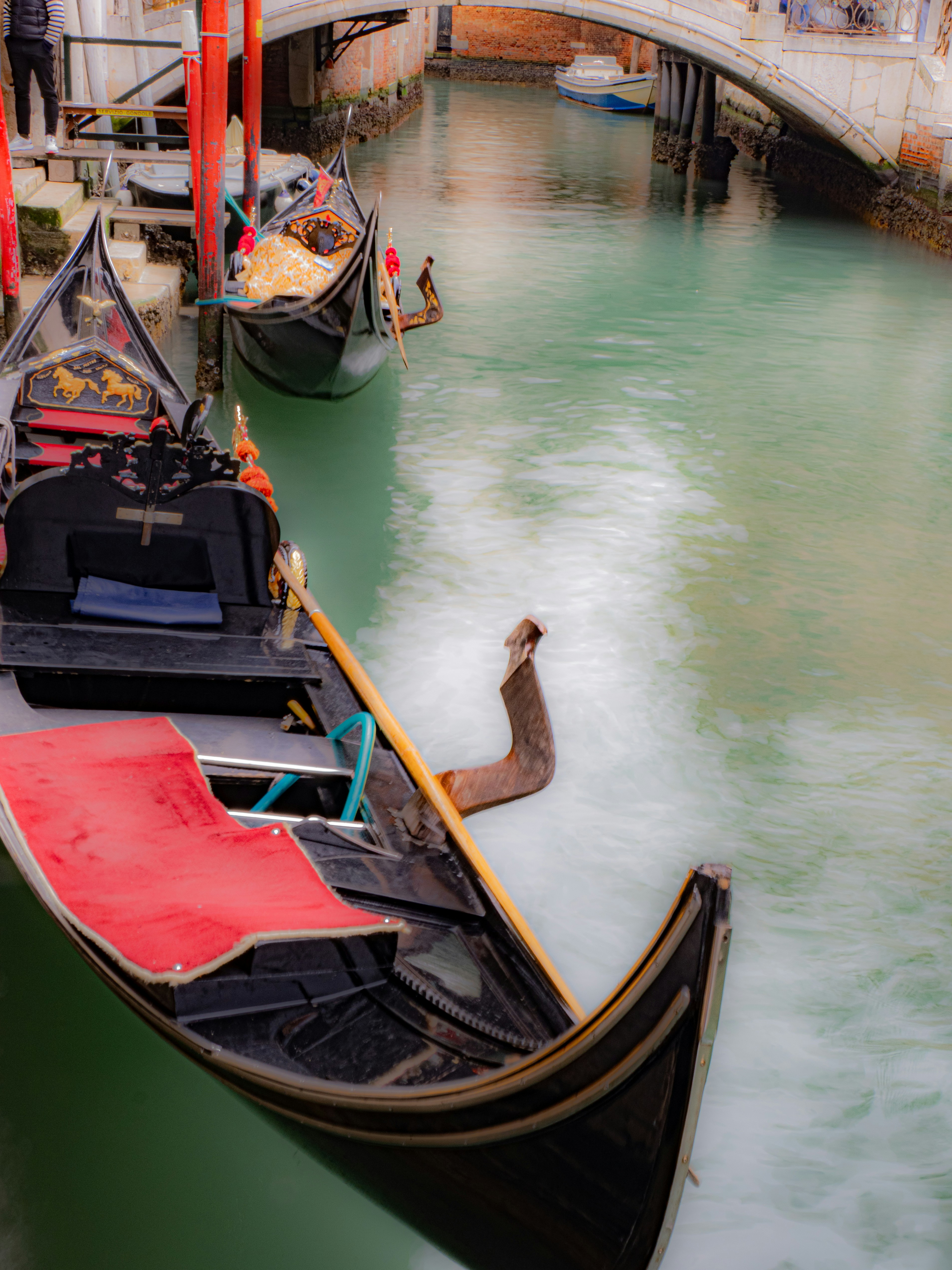 Gondola in the Silted Channel: Quiet Pause Under the Bridge