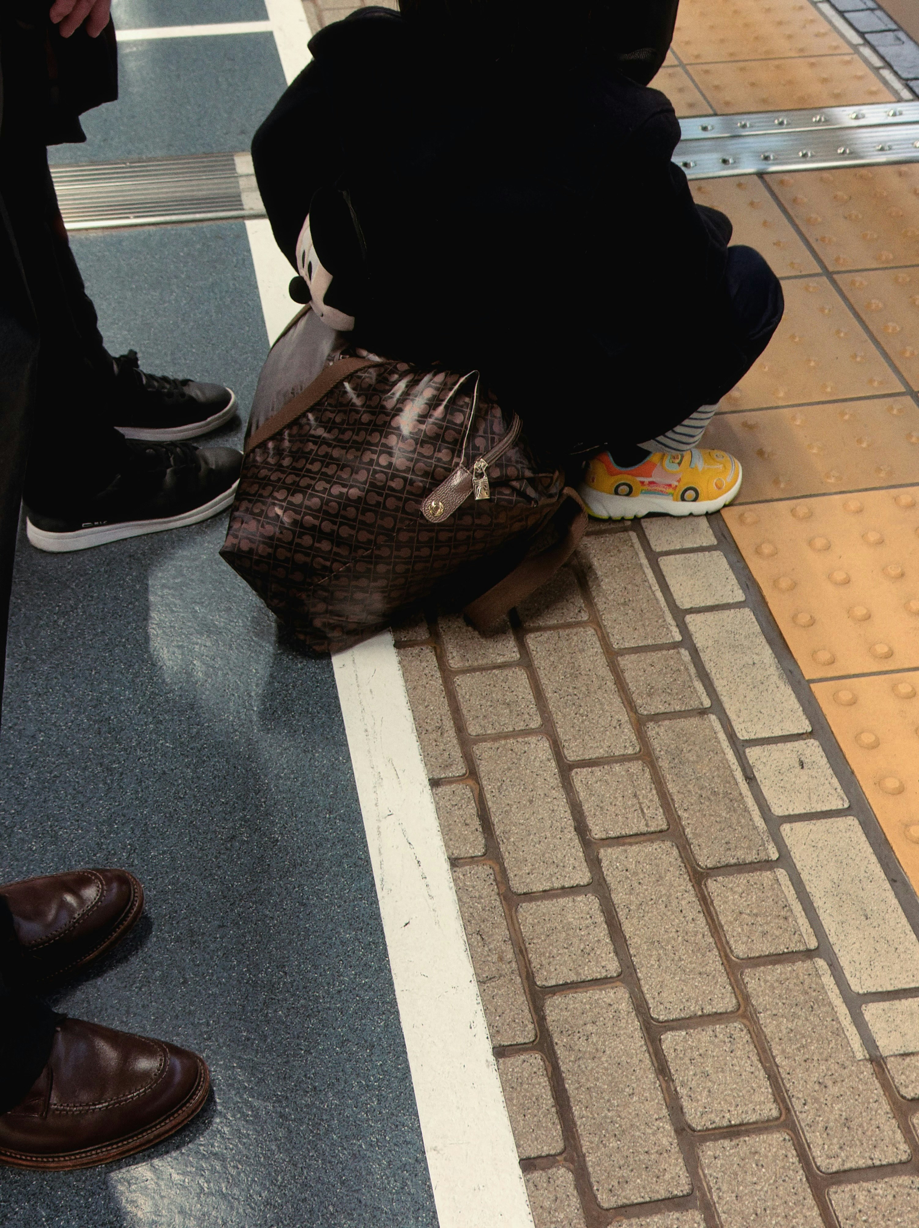Passengers at the Edge: A Folded Moment on the Platform