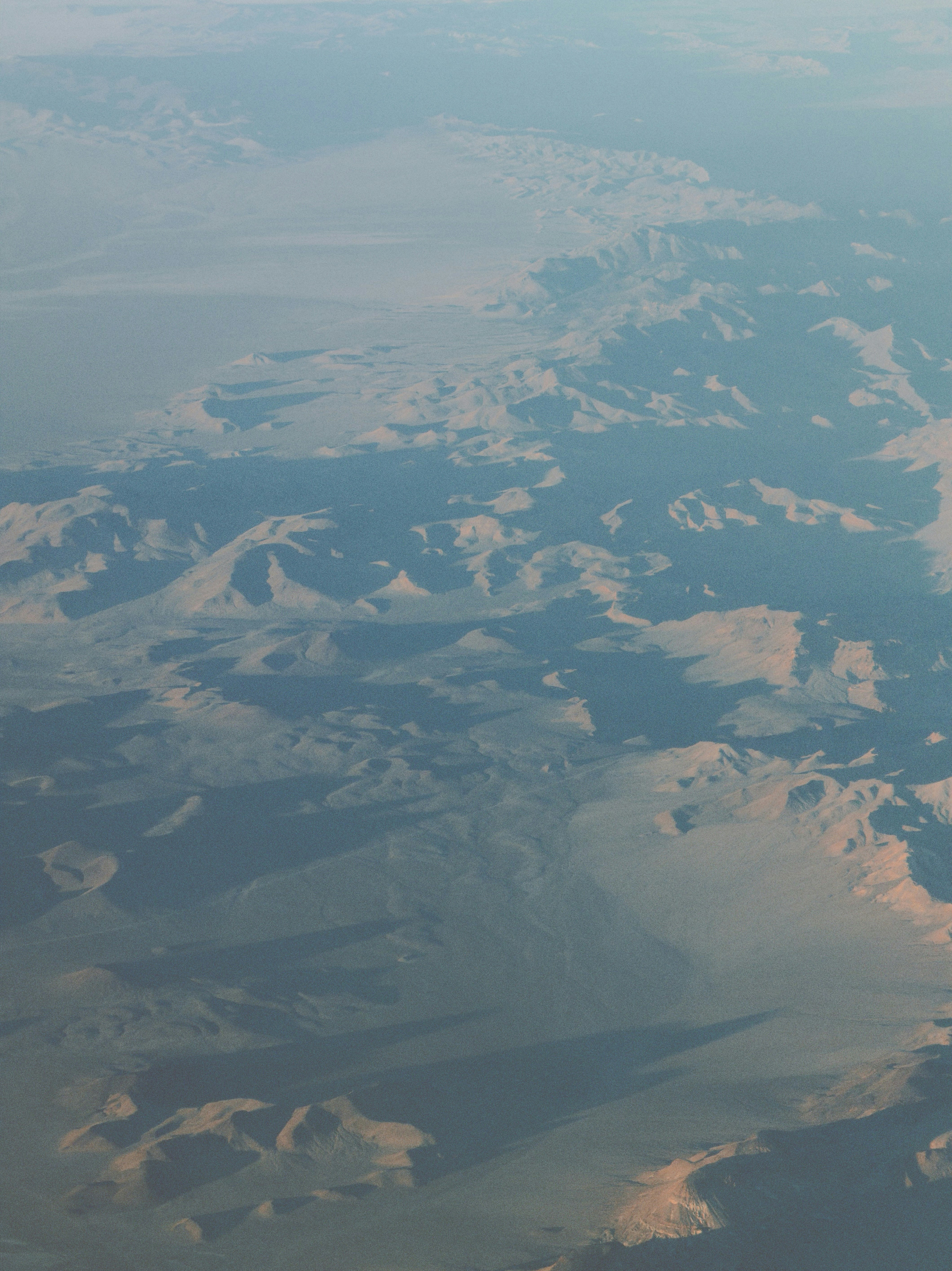 Aerial Palette: Desert Ridges Under Soft Sky