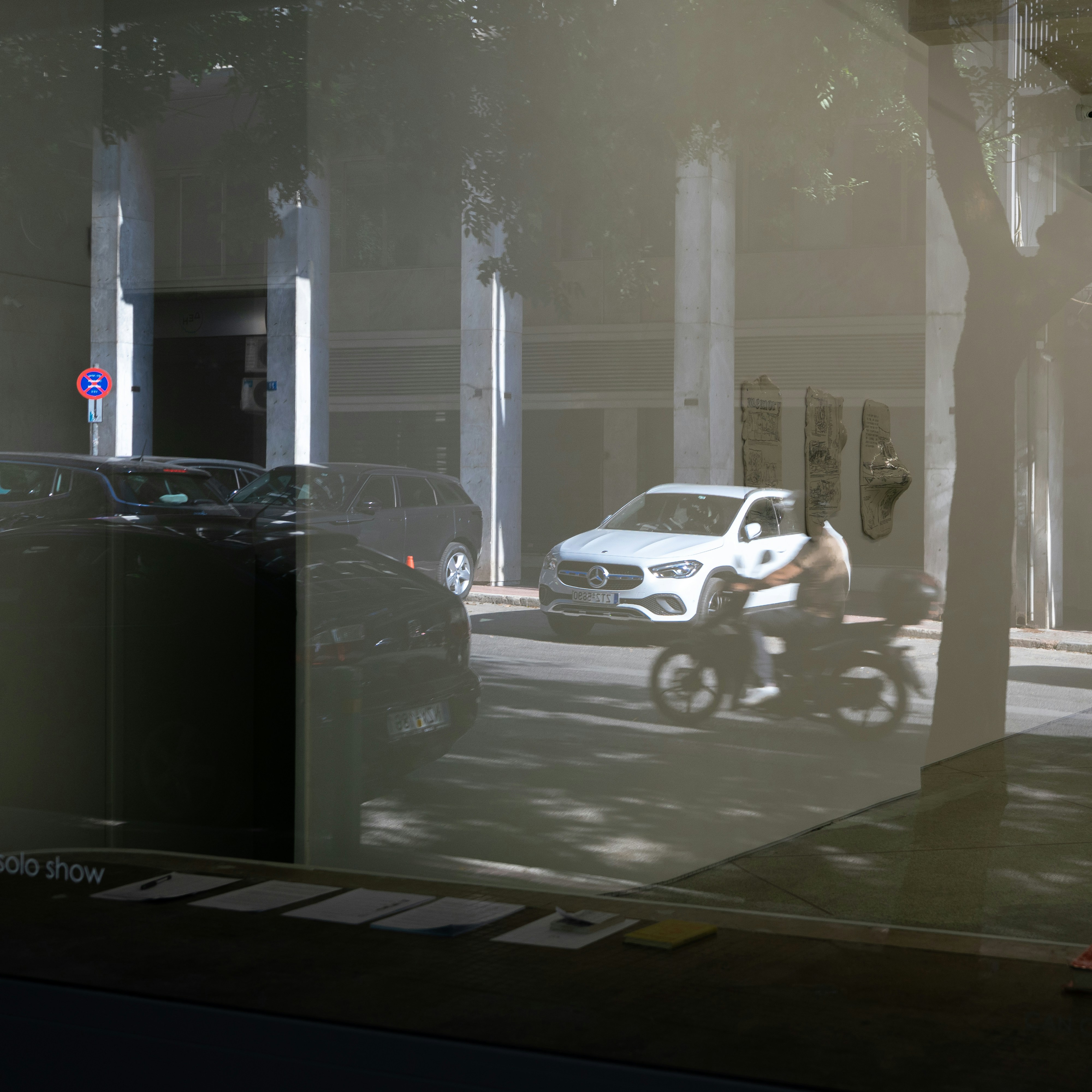 Passing Glance: A Quiet Street Scene Reflected Across Glass