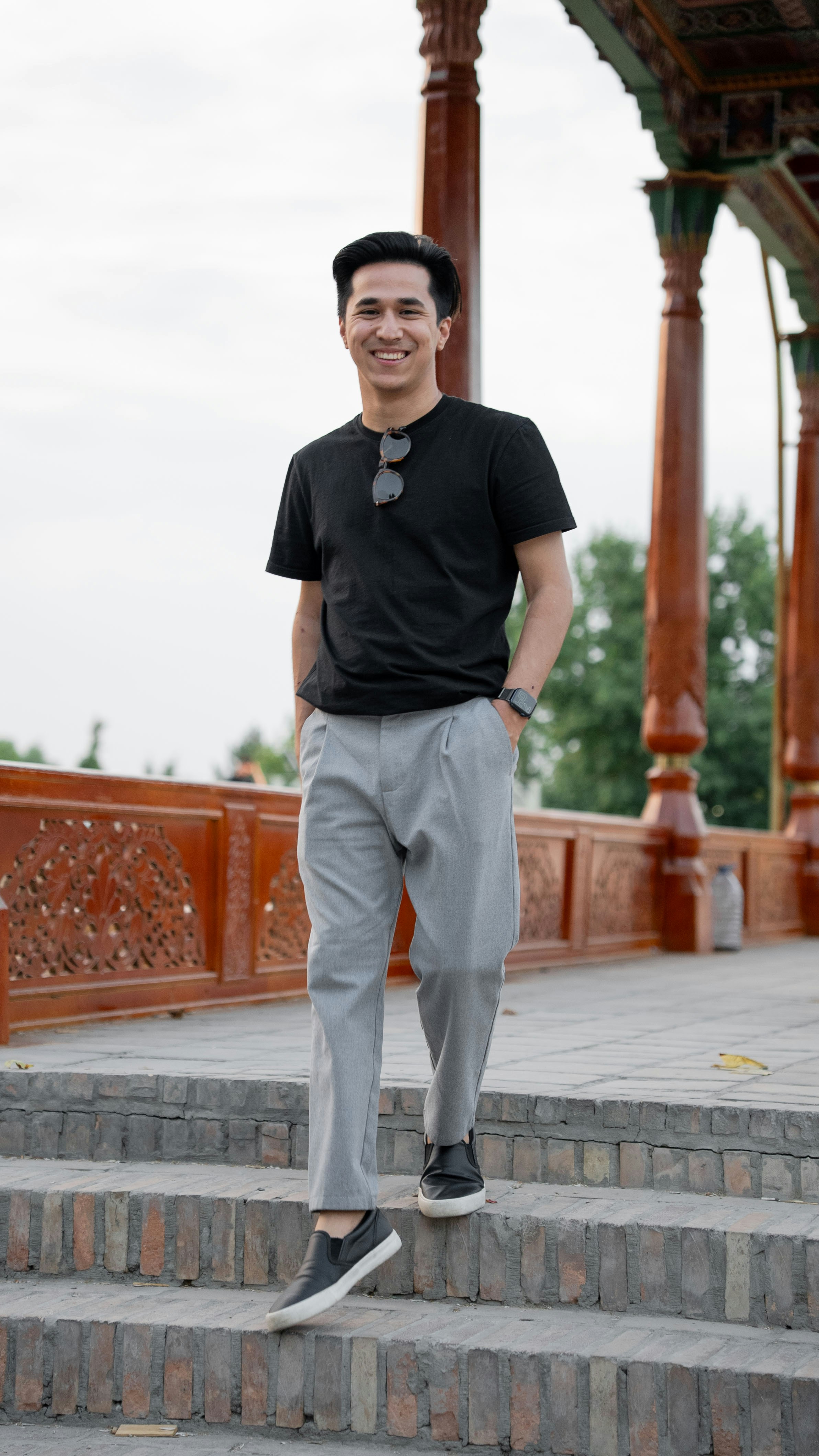 Smiling stride: a man in black tees climbs a decorative stair