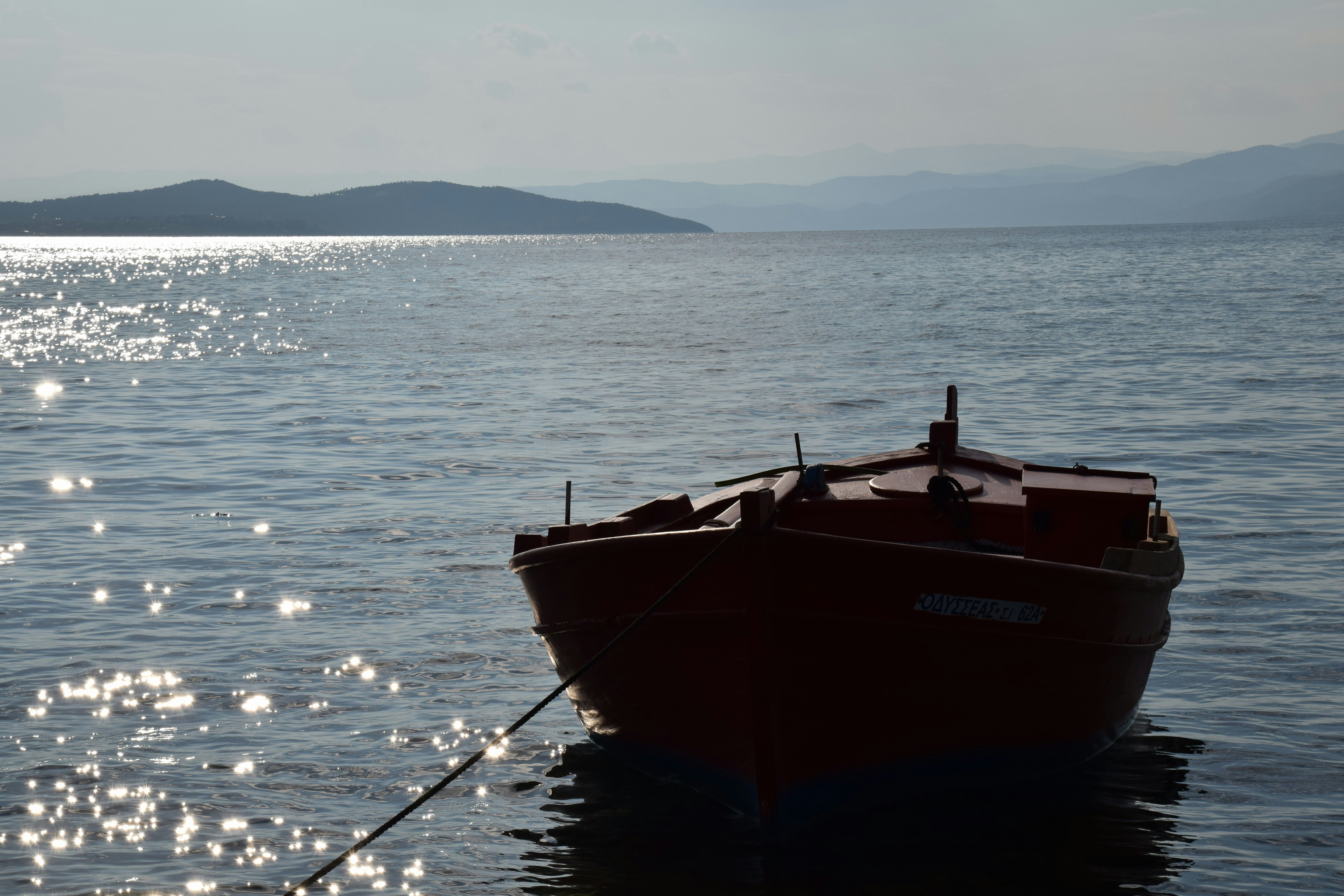 Red Boat at the Quiet Margin of Dappled Water