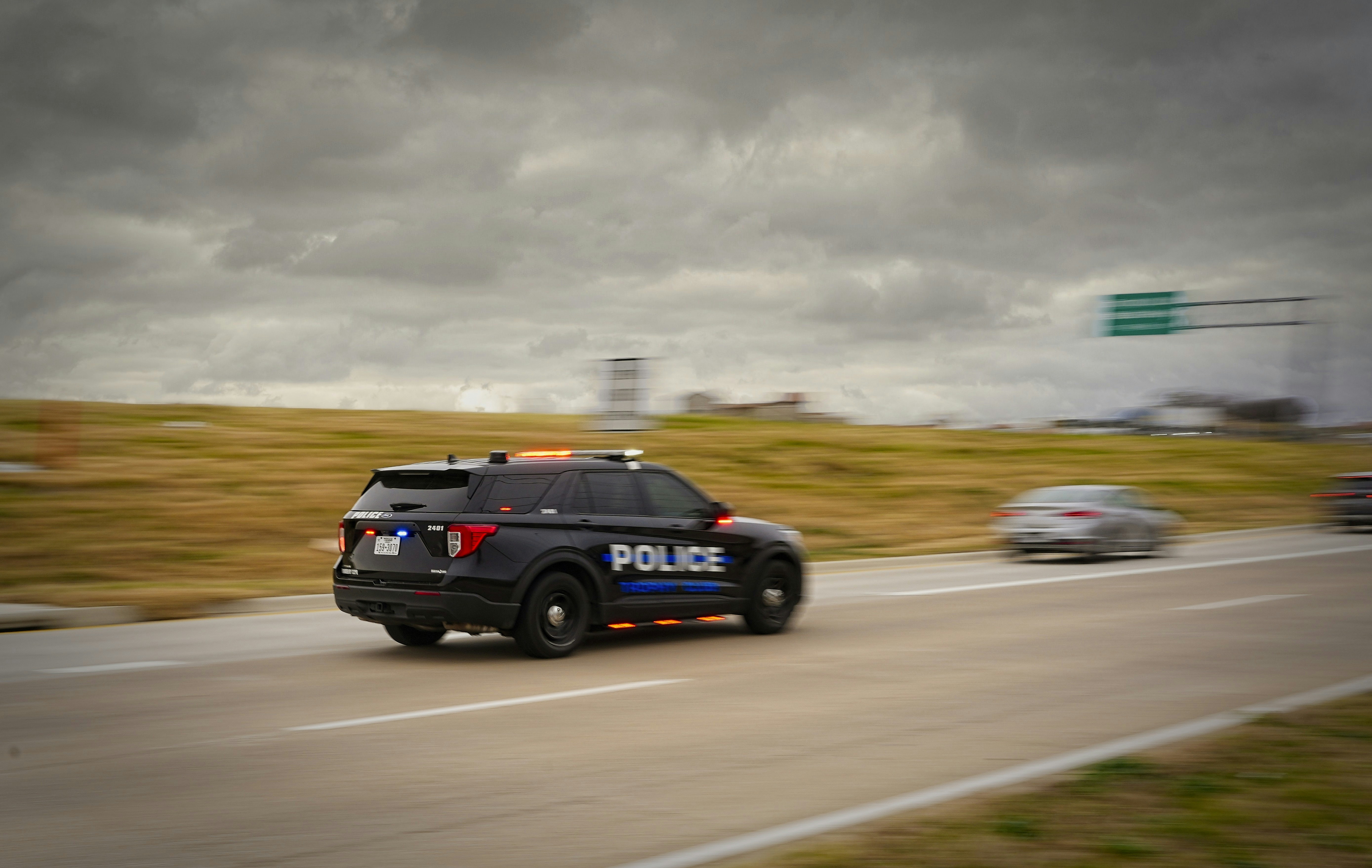 Pursuit on the Highway: Blurred Lights and a Police Cruiser