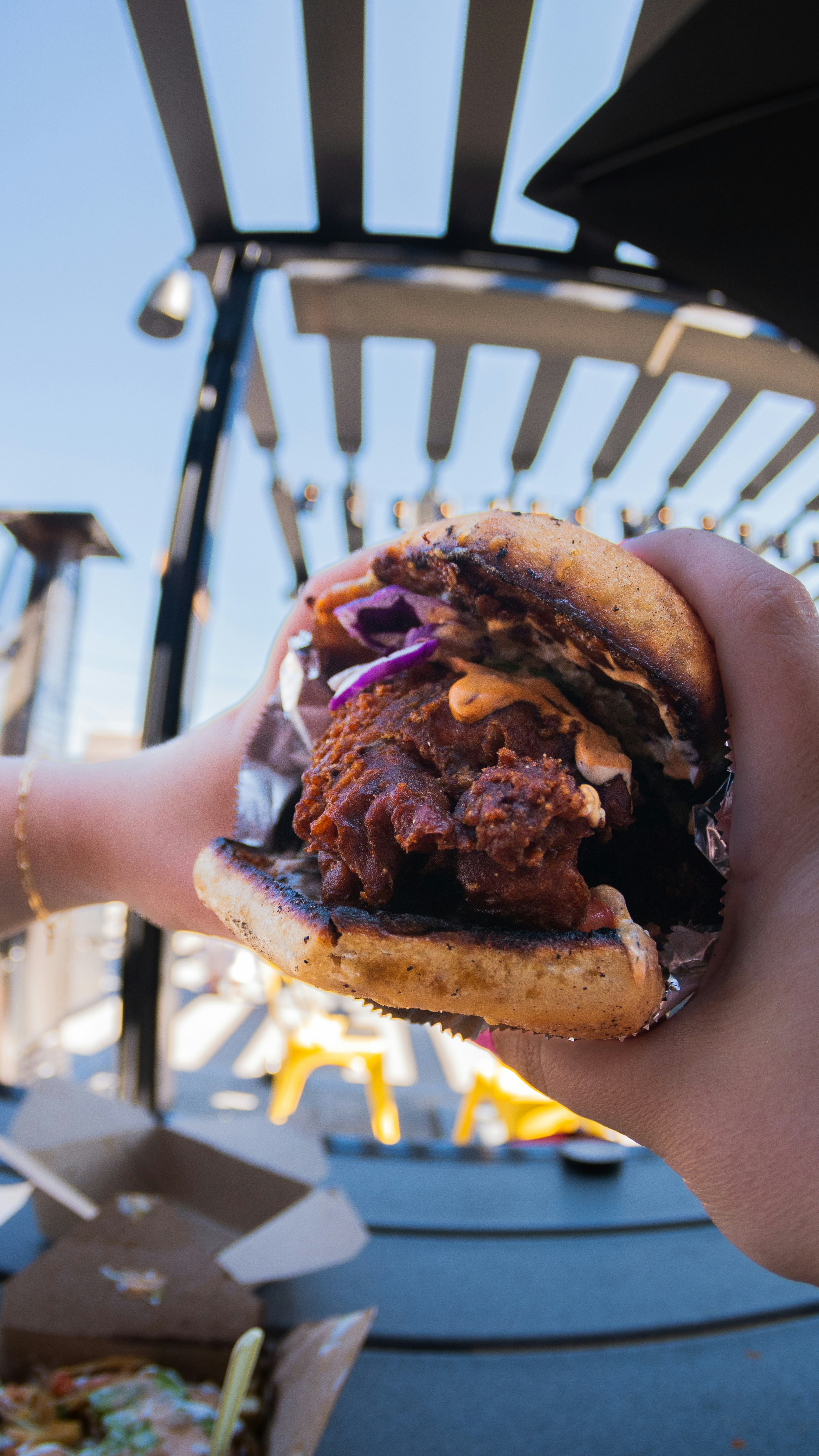 Handheld Feast: A Chewy Crunch Between Bite Marks and Blue Sky