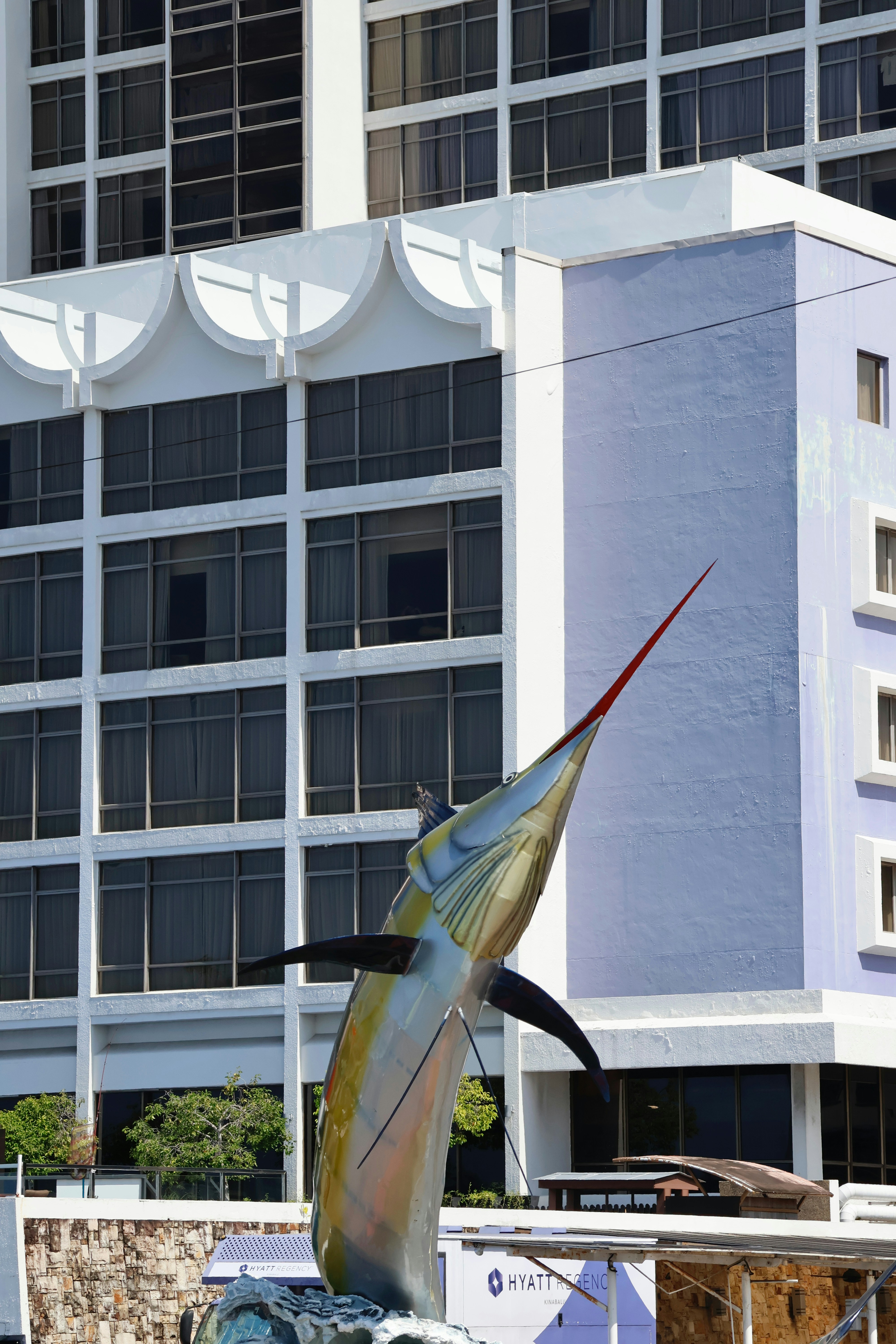 Large marlin sculpture in front of modern buildings photo – Free ...