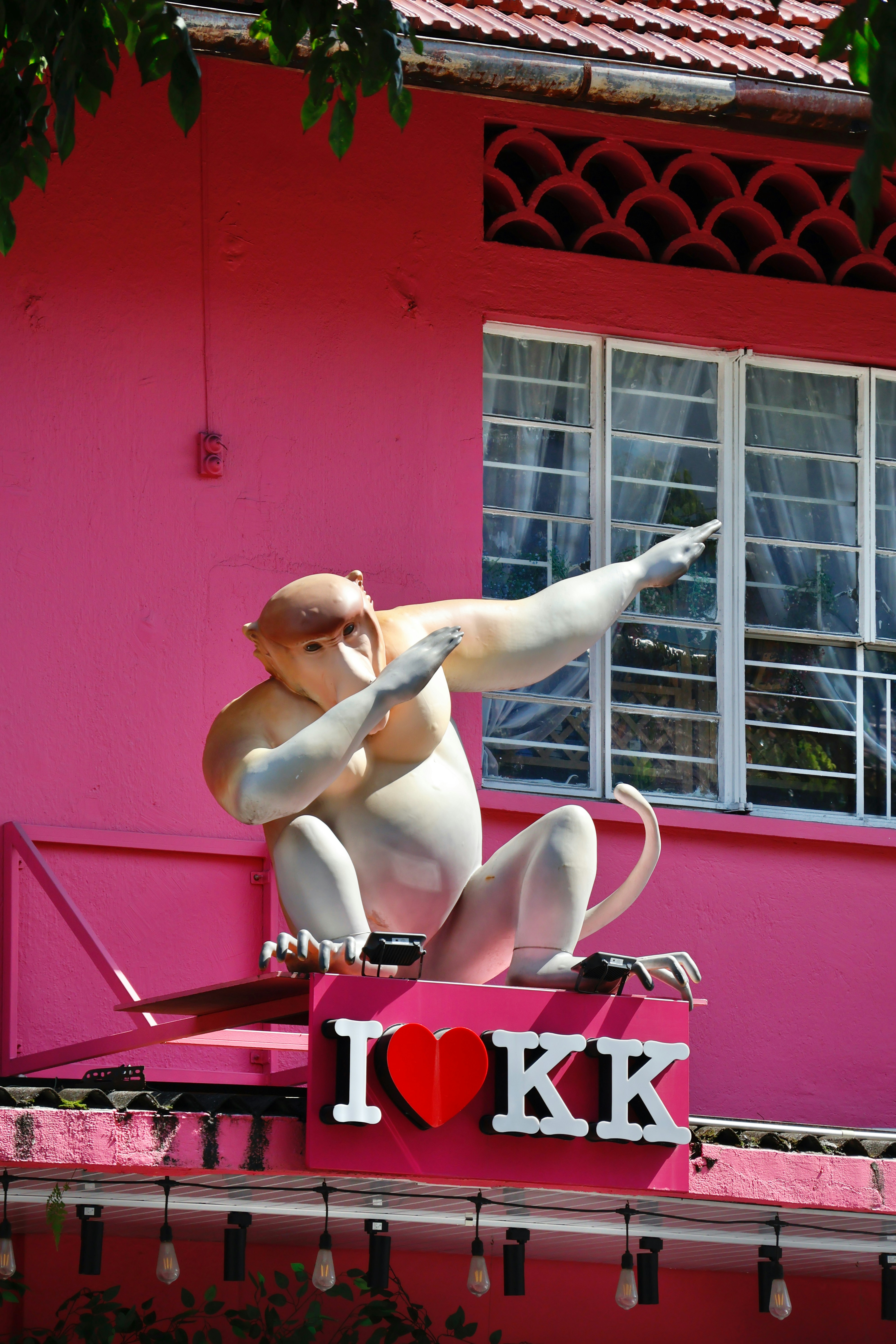 Pink Facade, Playful Statue, and a Heartfelt Sign