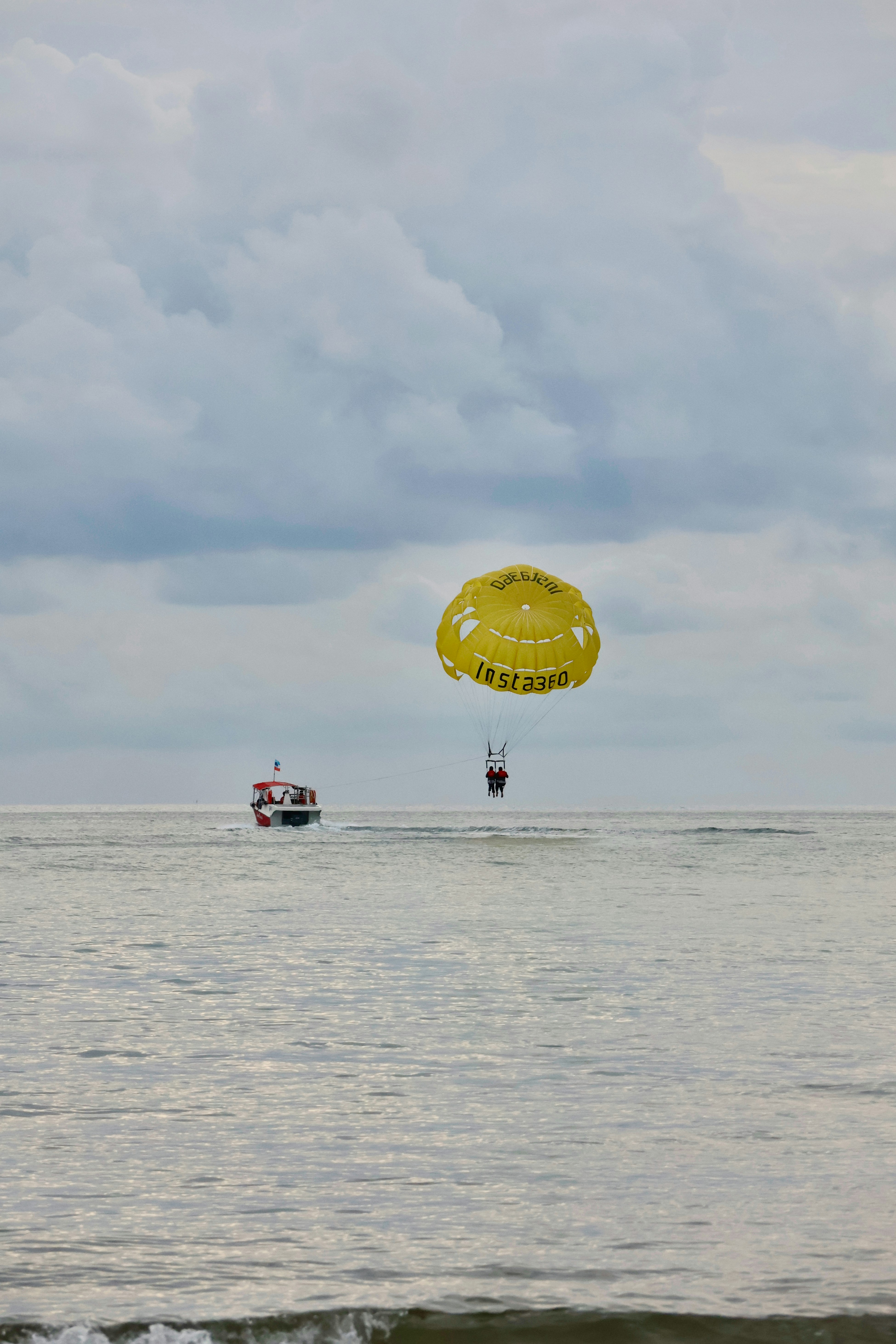 Yellow Parasail Ascendant Over Calm Sea