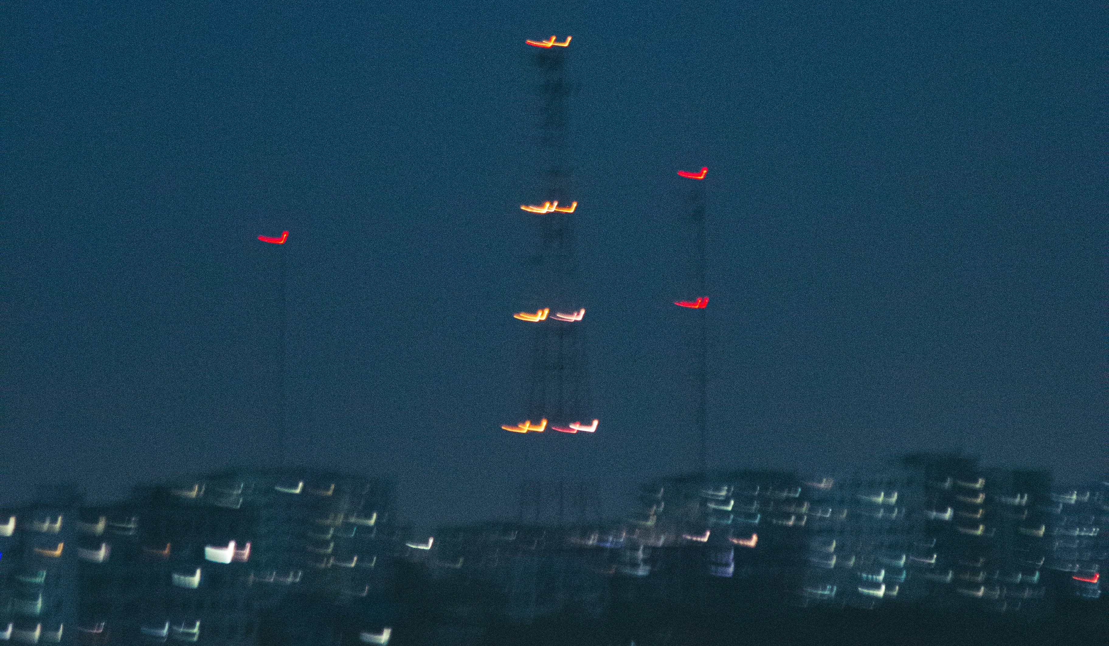 Blurred Beacon: Night Signals over a Cityscape