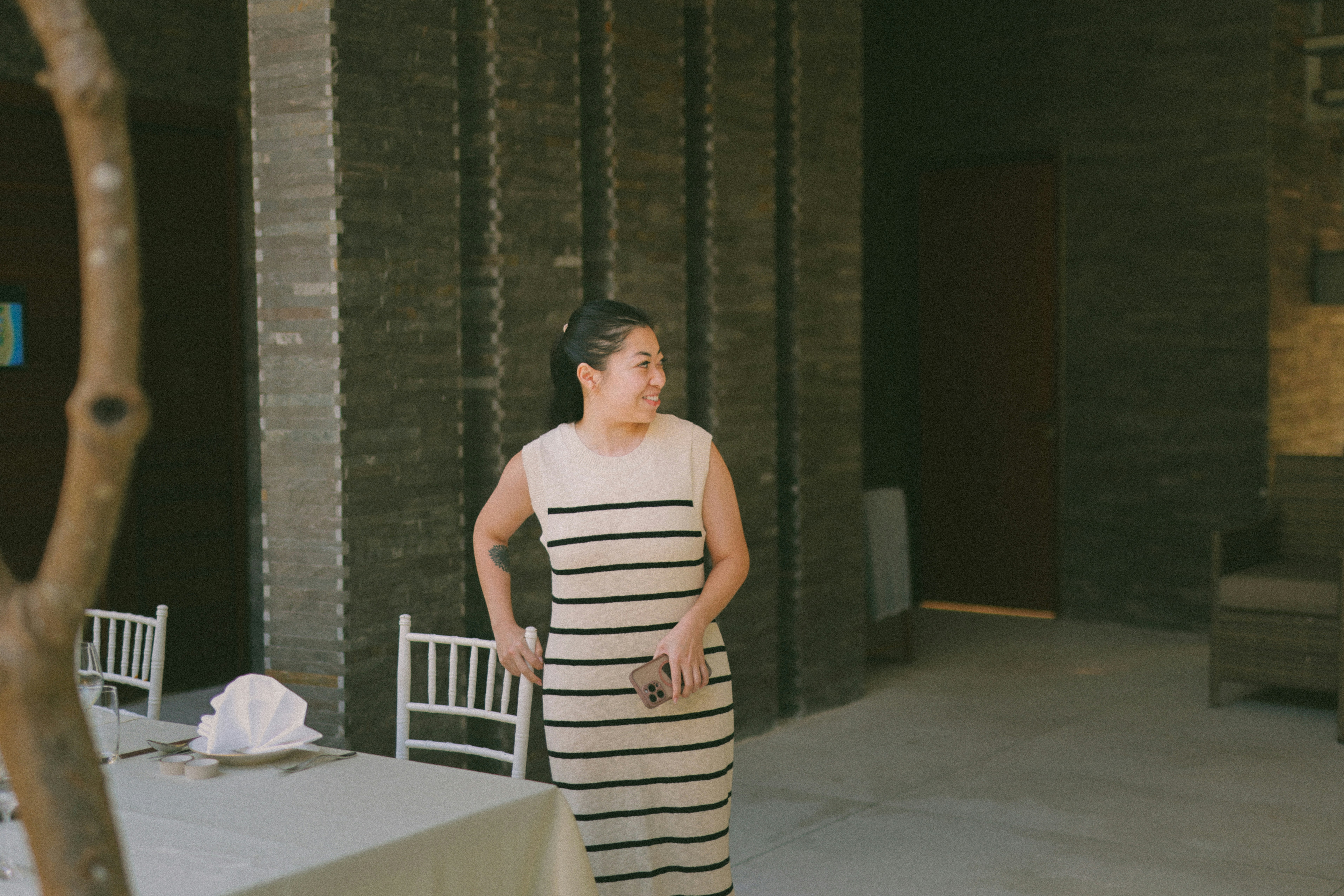 In-Place Grace: A Woman in a Striped Dress in a Quiet Courtyard