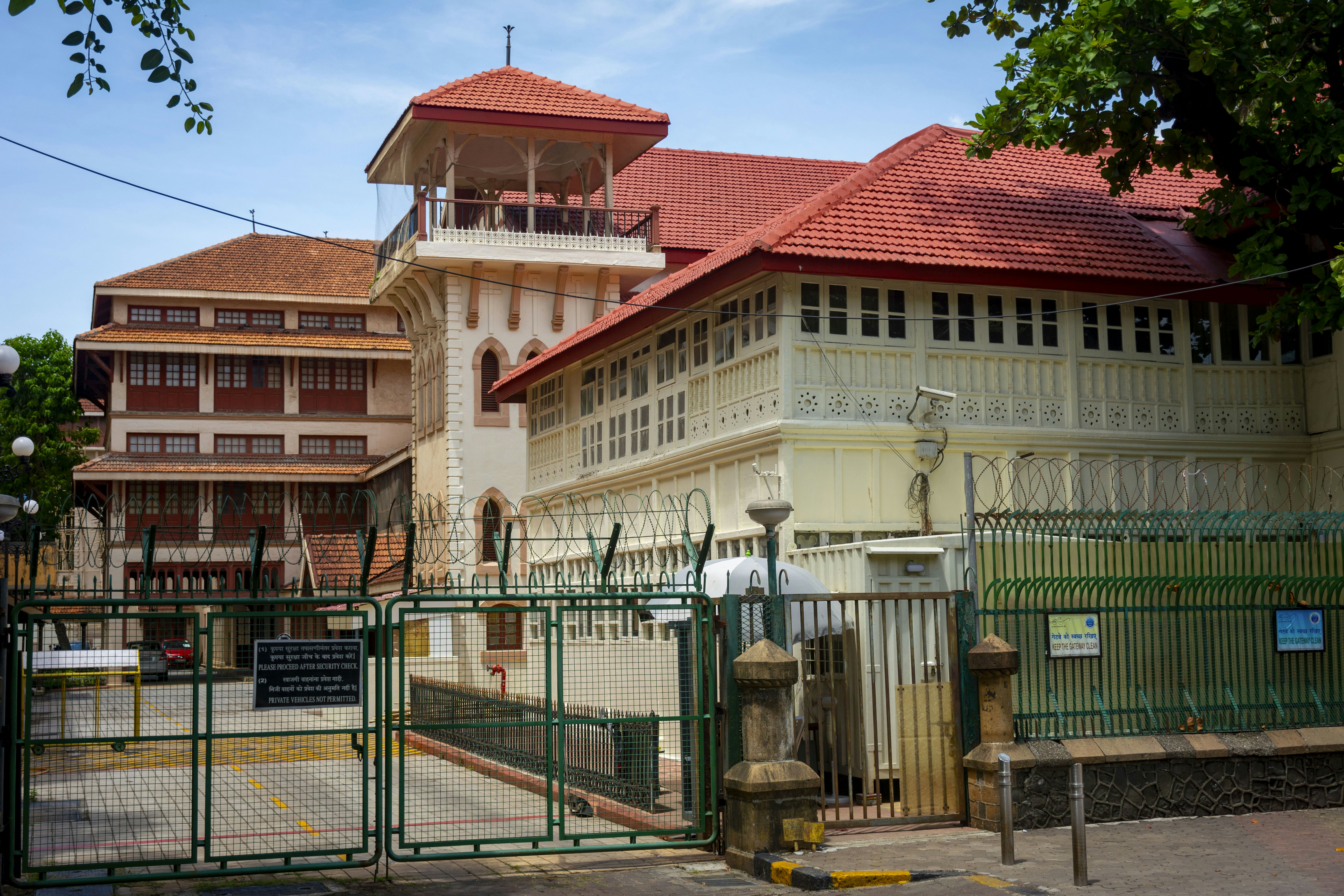 Colonial Villa Gate: Ornate Veranda and Red-Tiled Roof