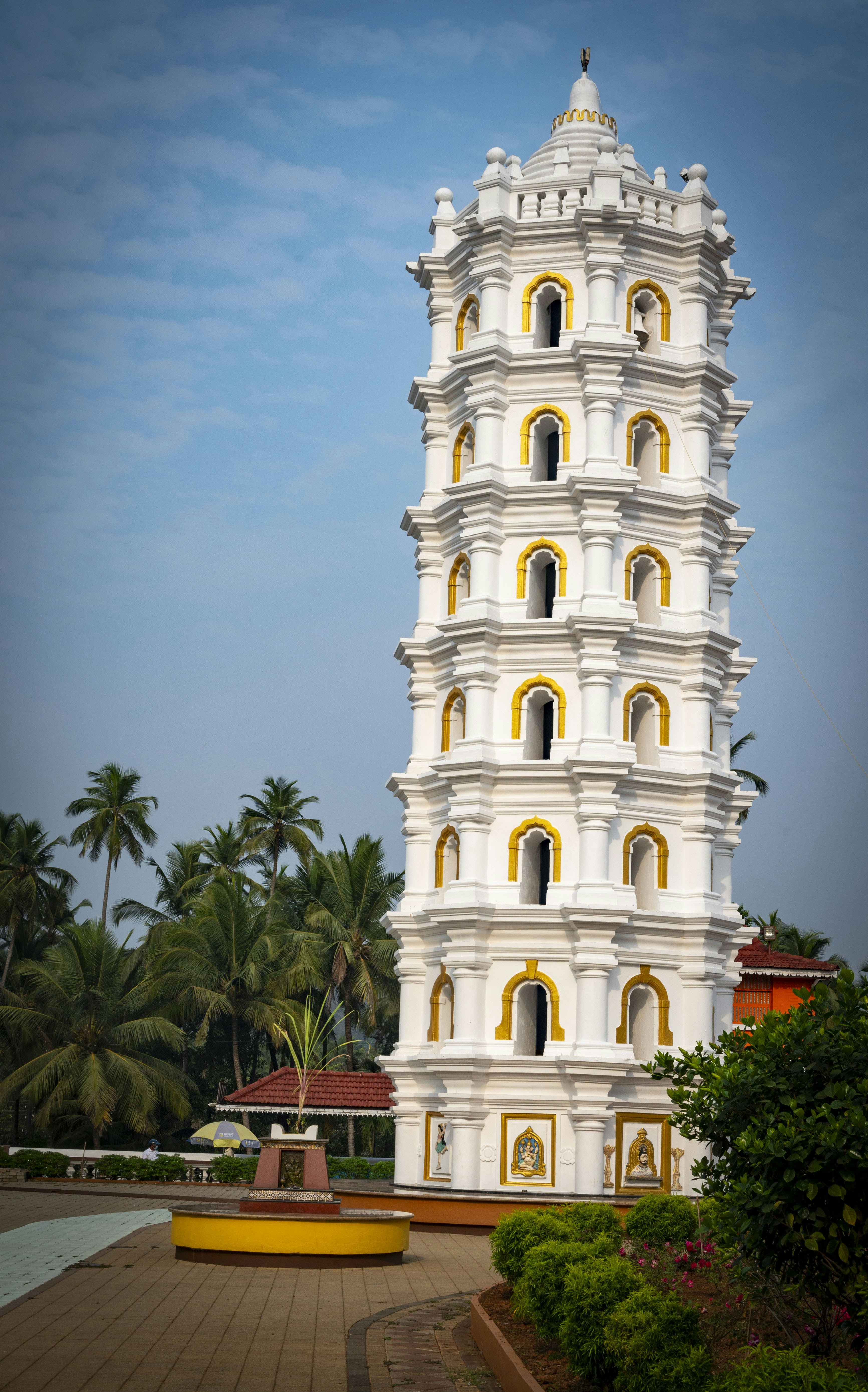 White Bell Tower Rising Over Palm-Dotted Grounds