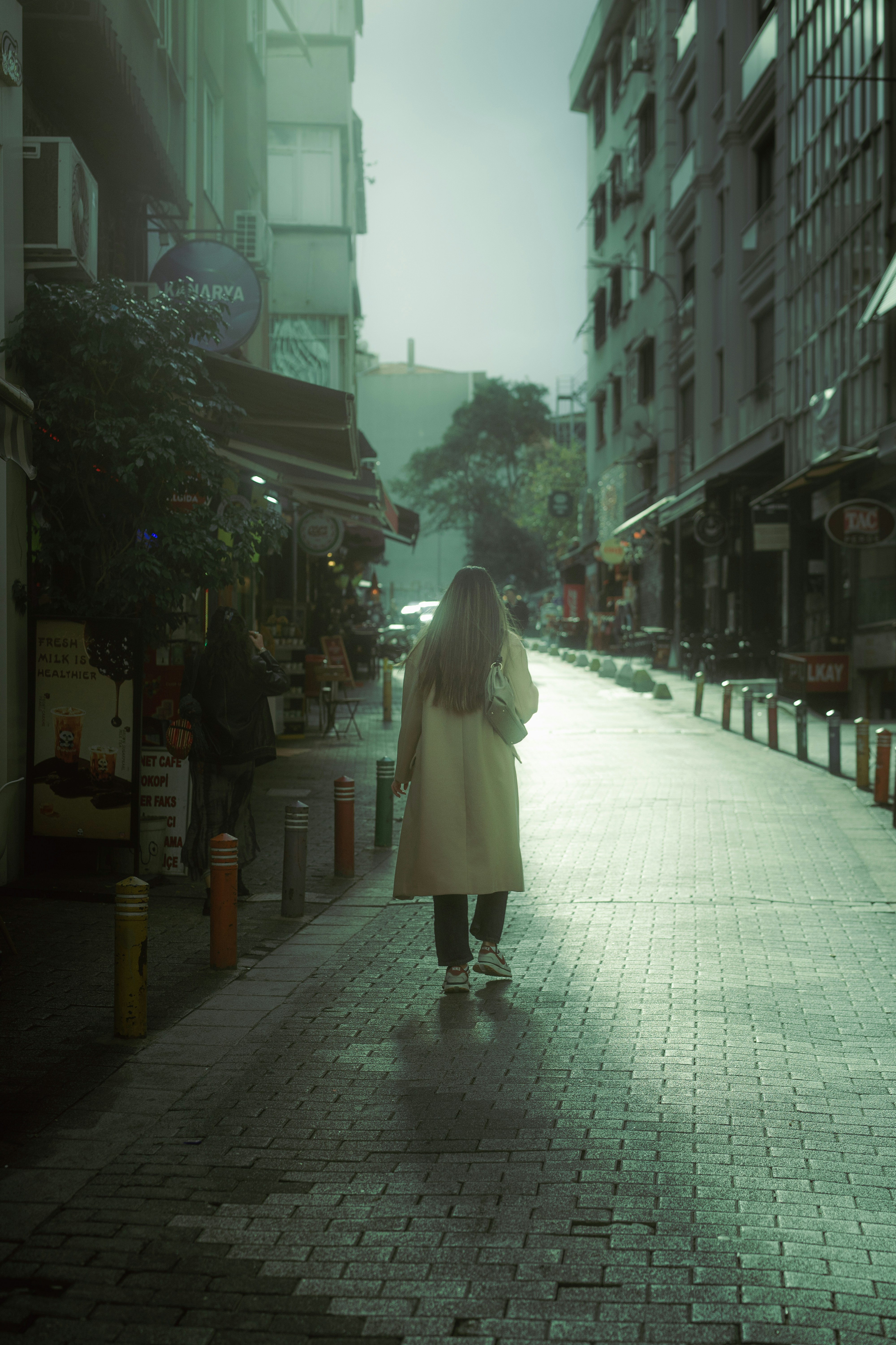 Backlit Quiet Walk: A Sole Traveler in a Sunlit City