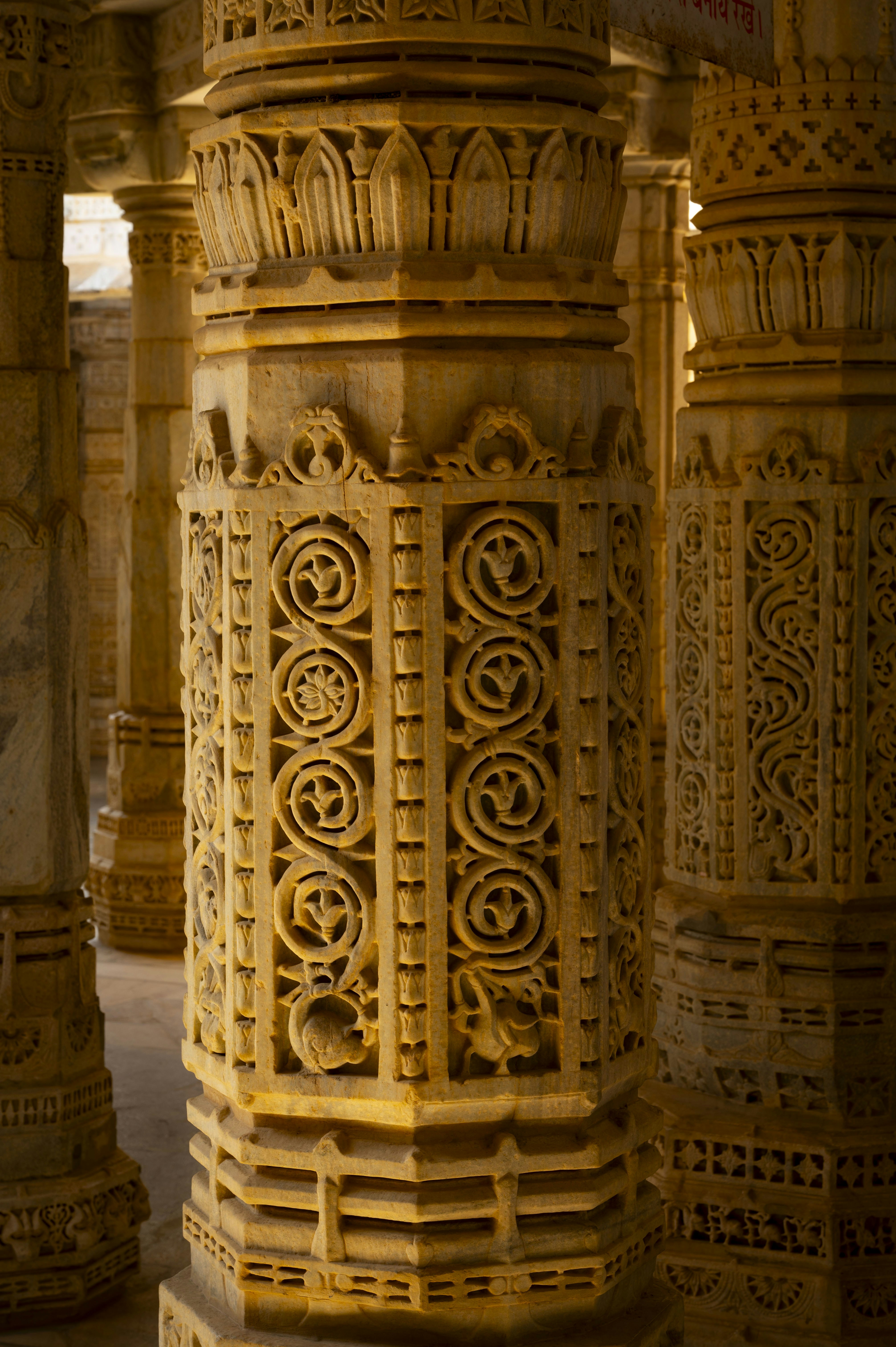 Carved Column Relics: Warm Hues and Repeating Scrolls