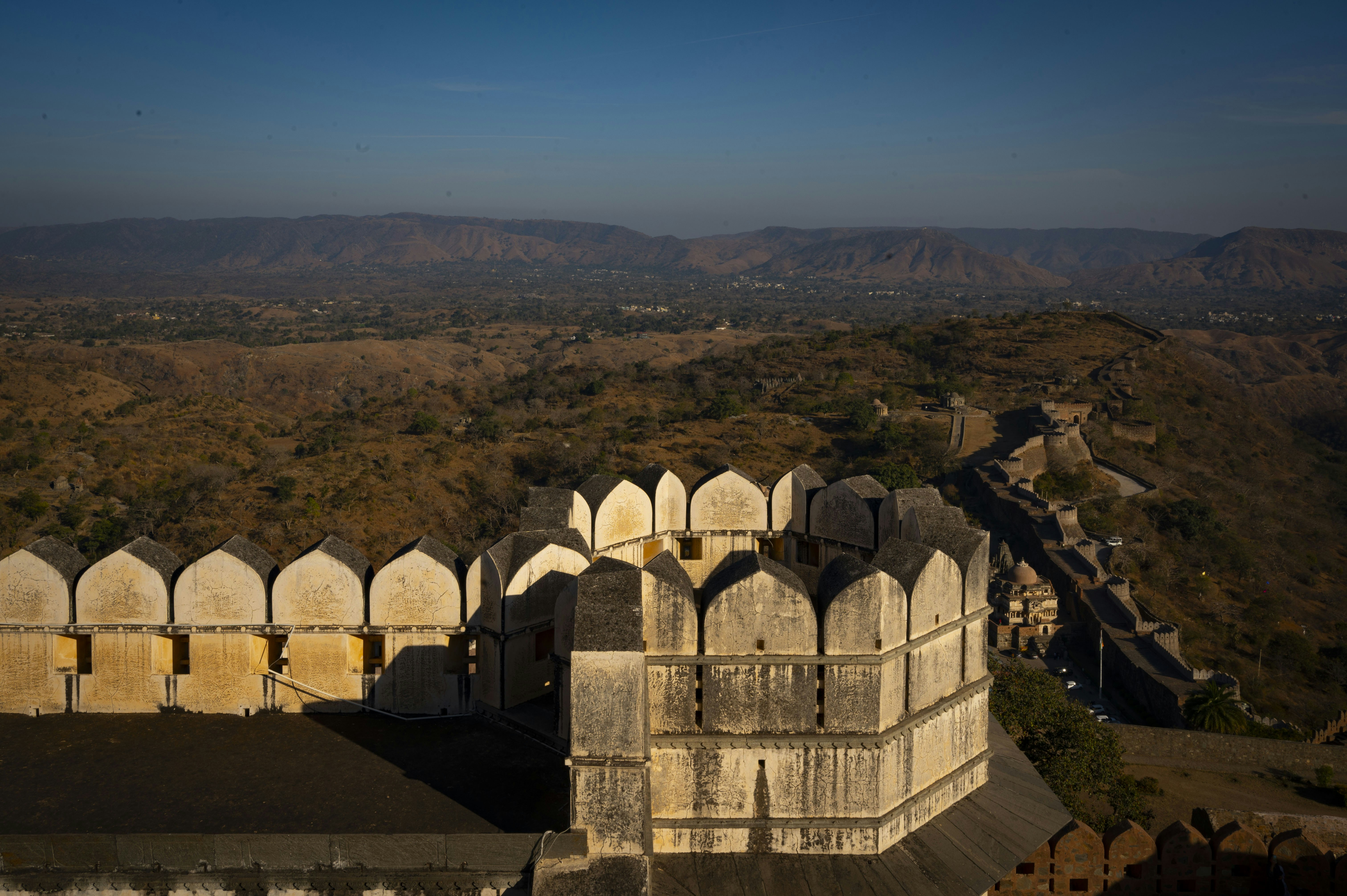Fortress Tiers: Sunlit Parapets Over a Rolling Desert Ridge