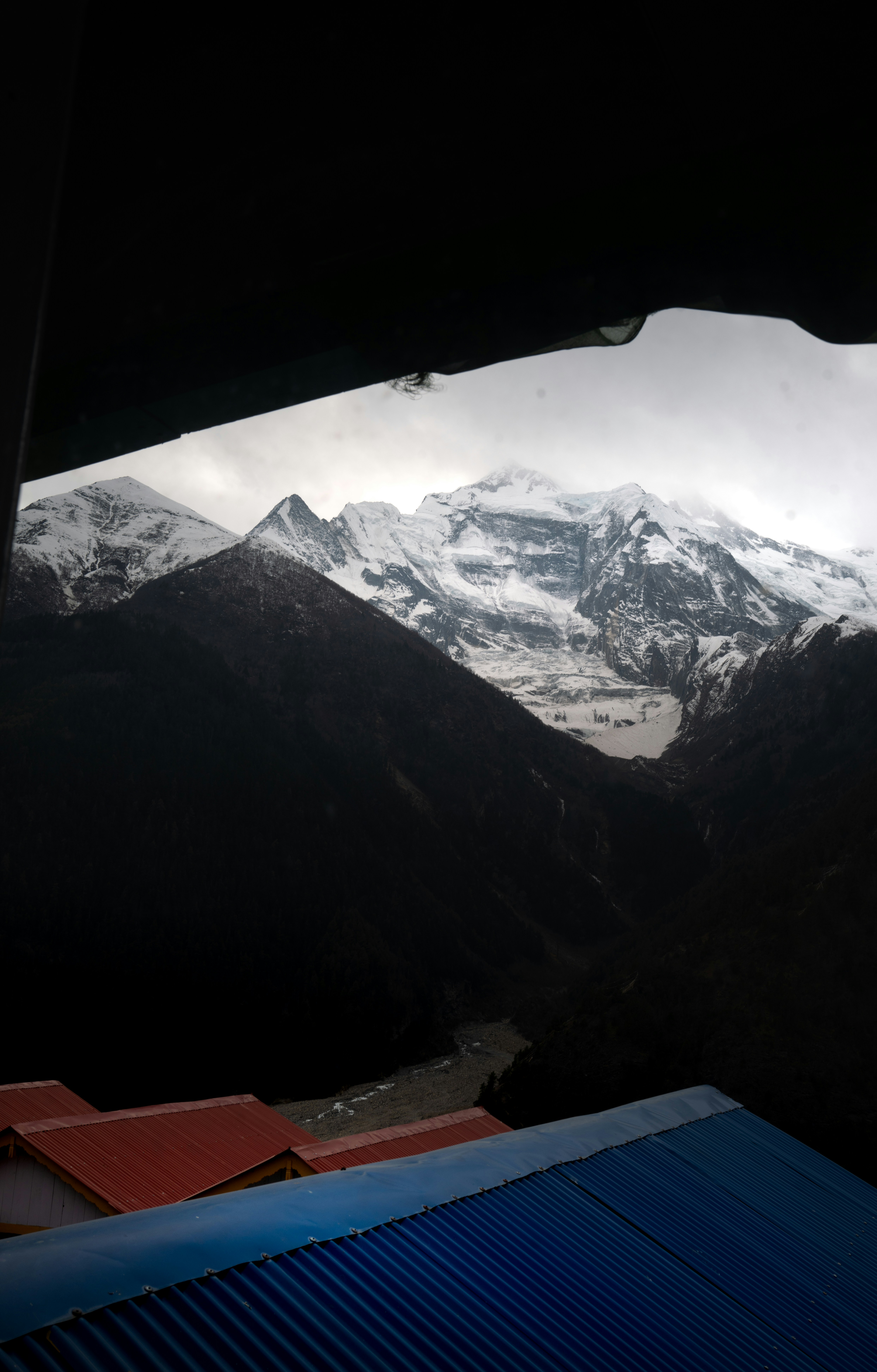 Snowbound Ridge Framed by a Colorful Roof