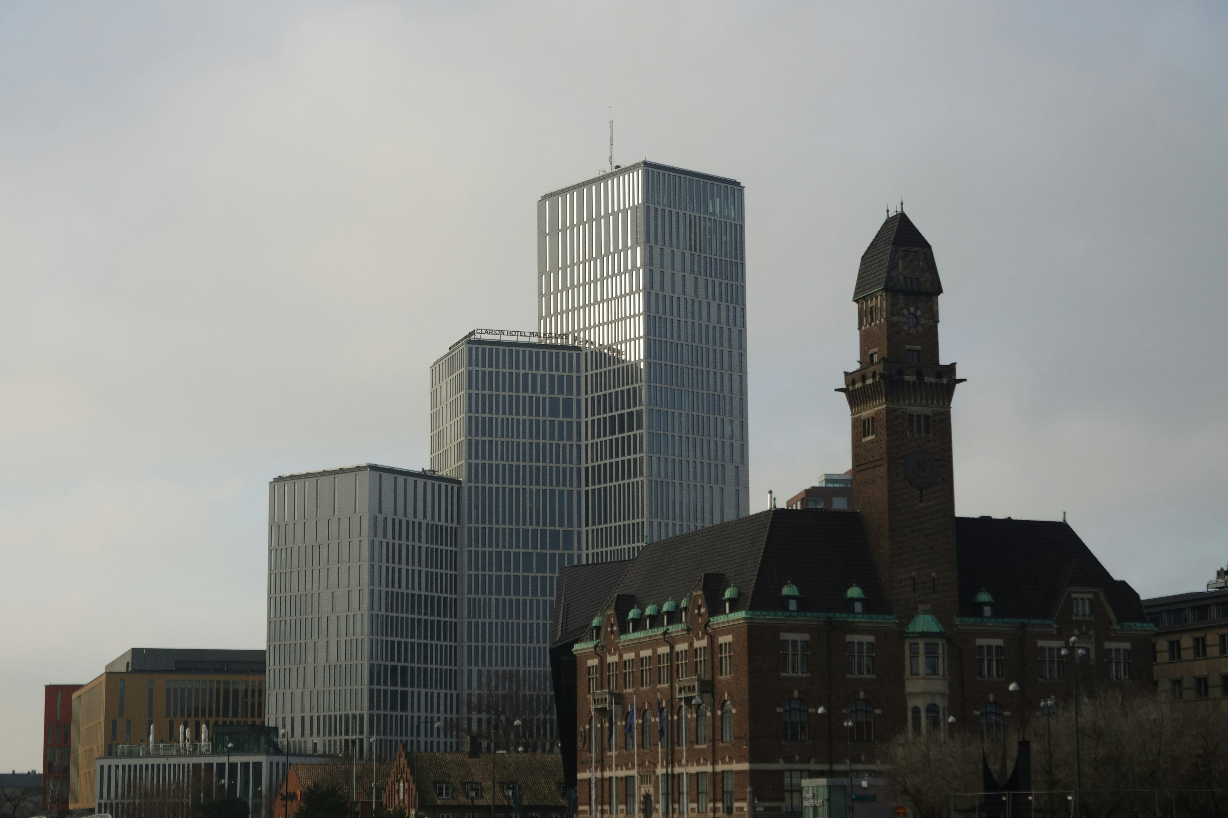 Old Clock Tower Meets Modern Glass: A City Portrait at Dusk