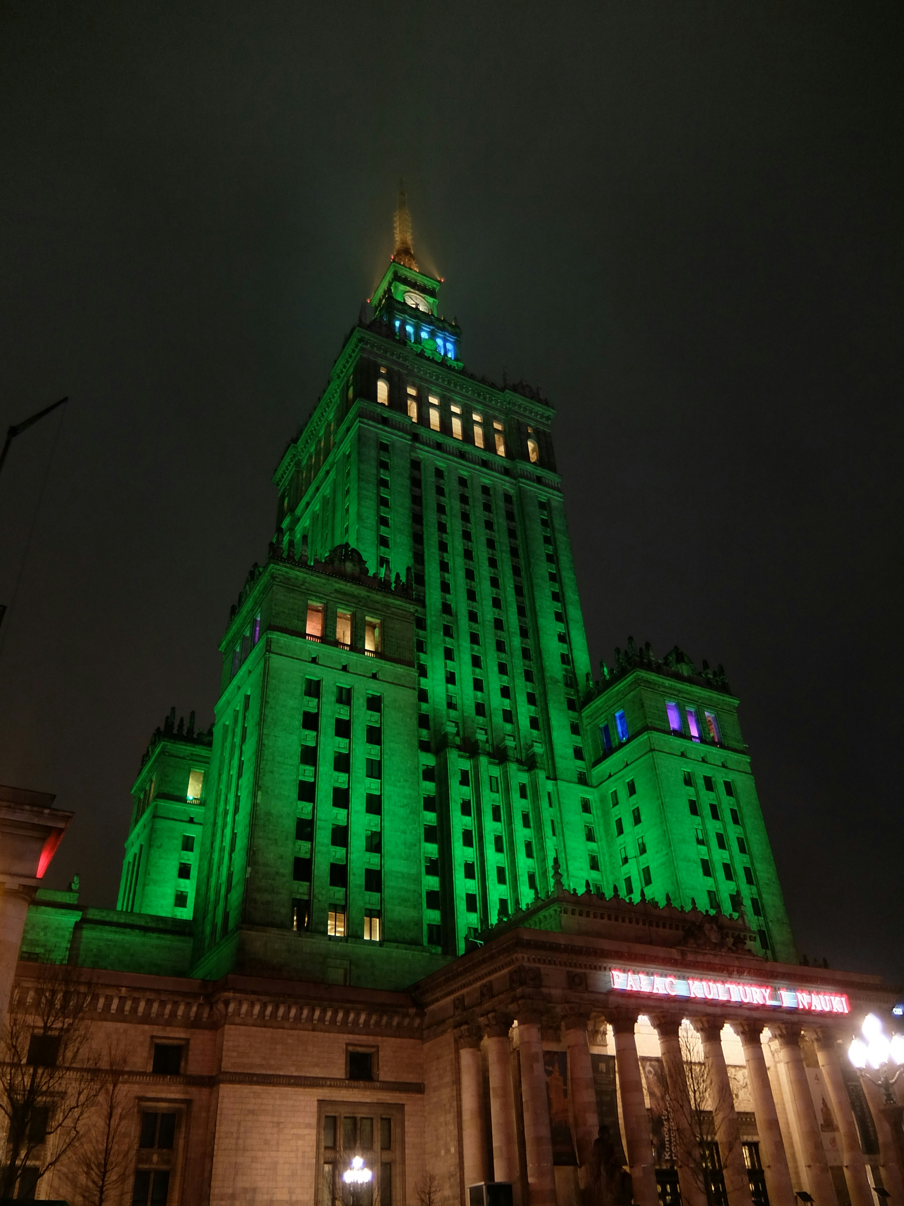 Green Tower at Night: A Neon-Illuminated Neo-Classical Spire