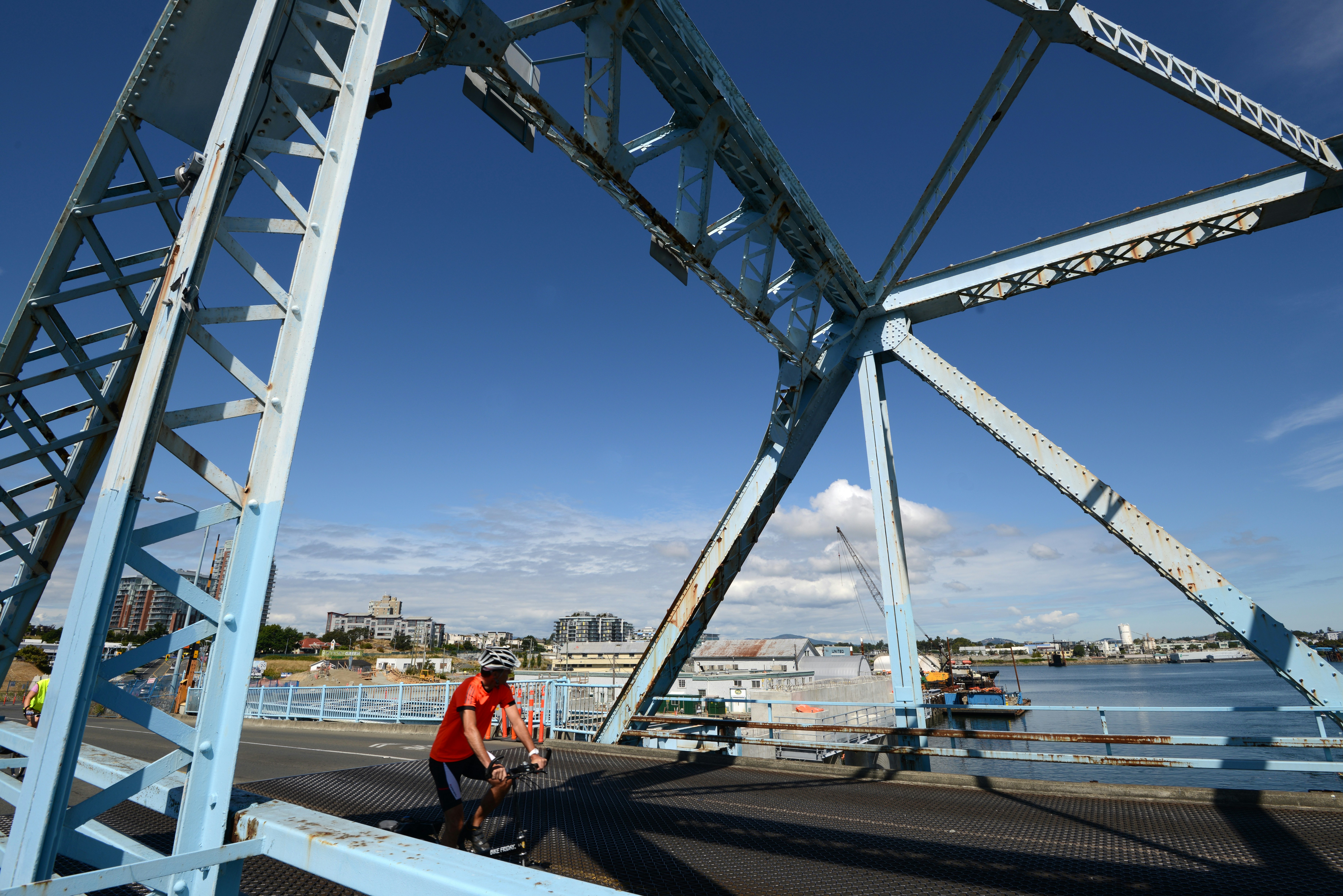 Red-Clad Rider on a Blue Steel Bridge