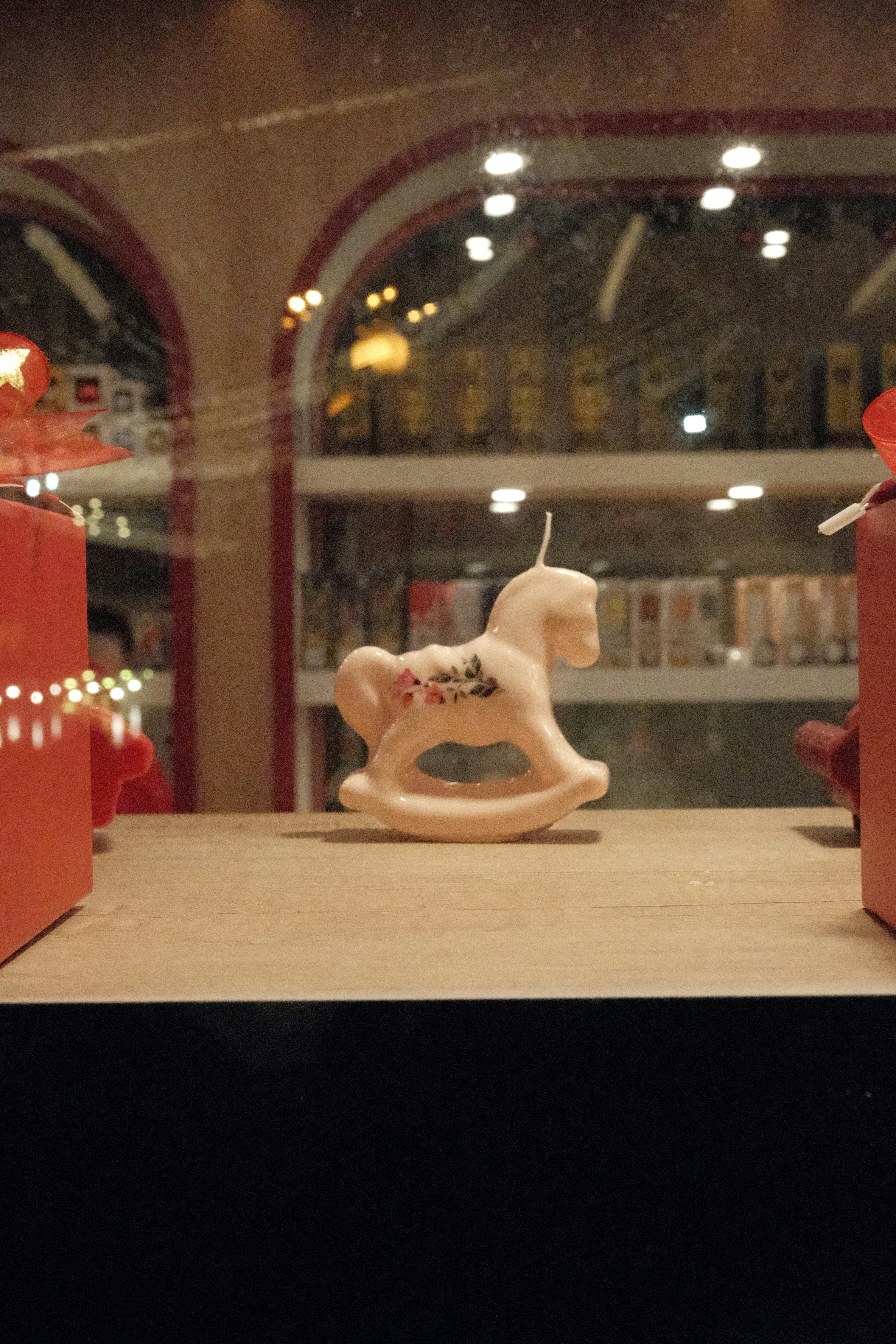 Waxen Carousel: A Candlelit Trinket Centered on a Quiet Shelf