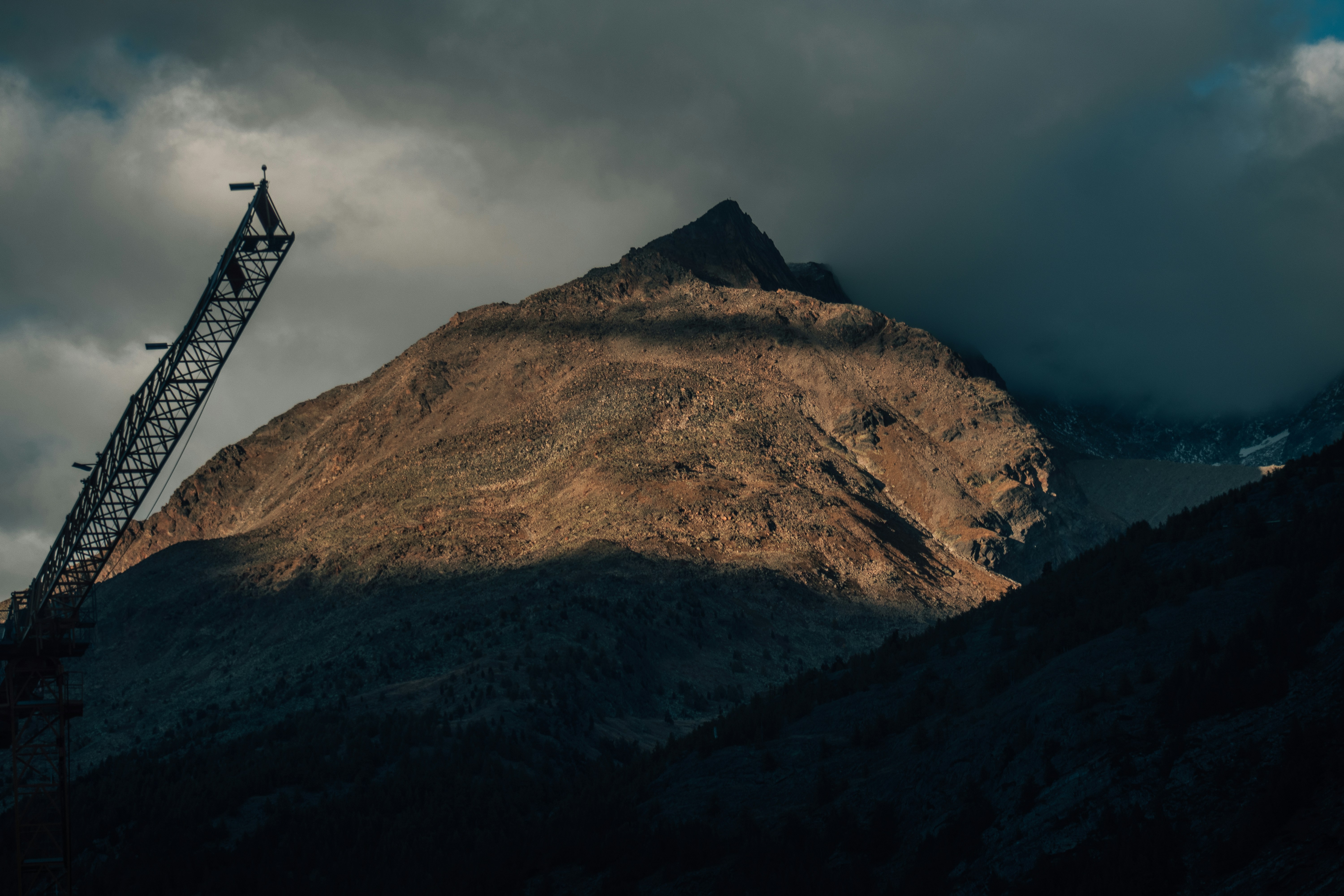 Sunlit Peak Pierced by Shadow: A Mountain Under Construction