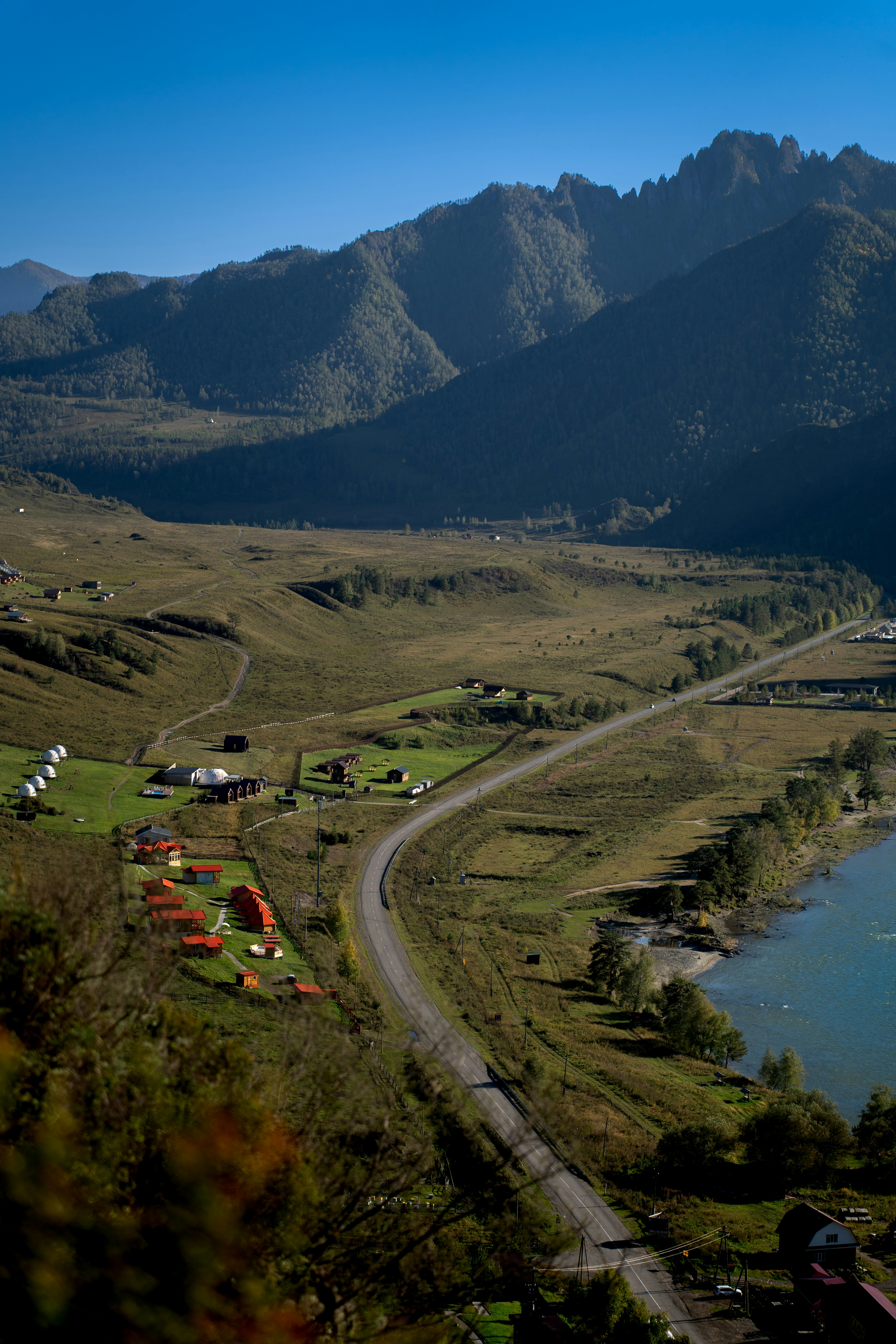 Road through the valley toward the shadowed mountains