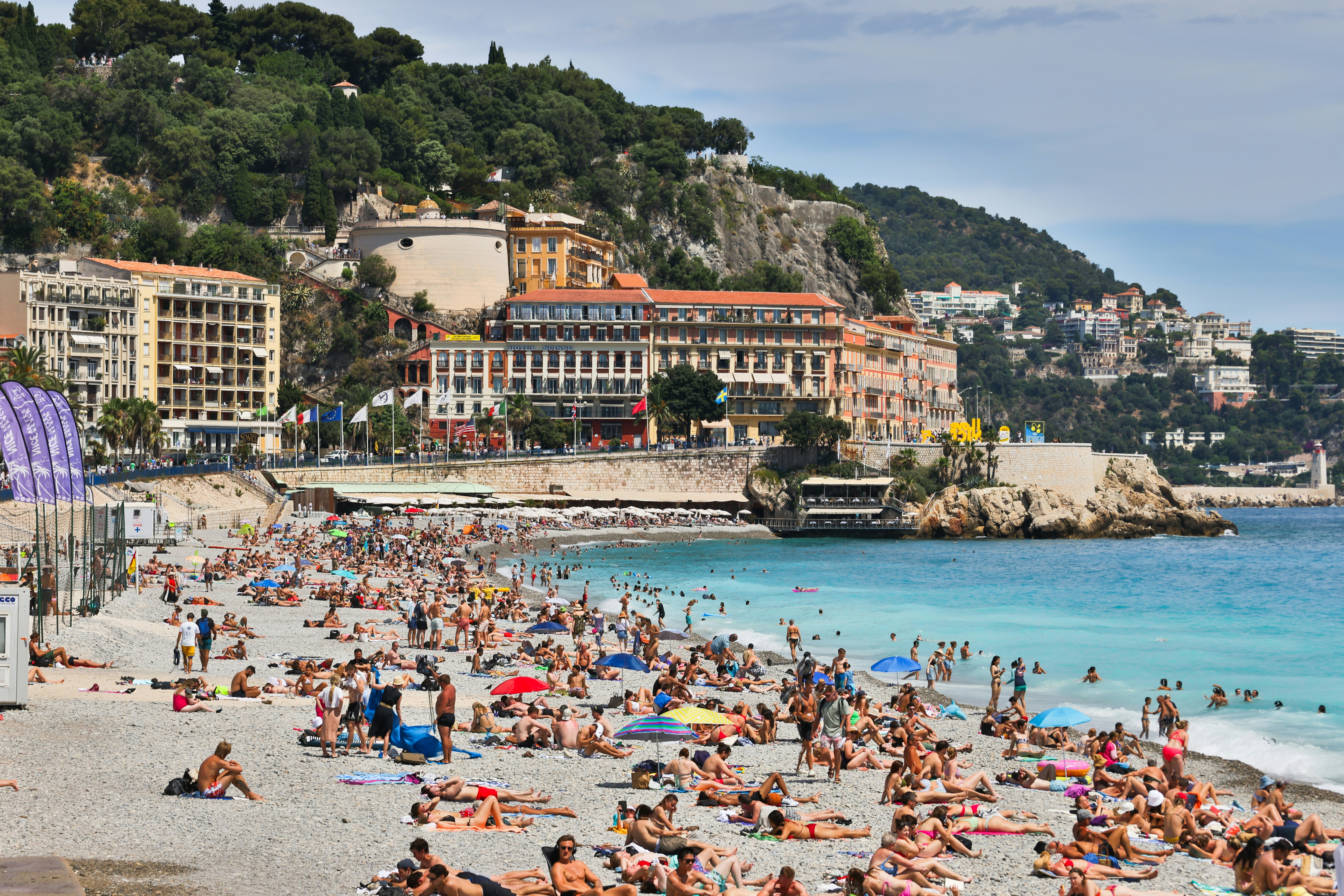 Sun-Soaked Riviera Beachfront: A Sea of Umbrellas and Lime-Toned Waters