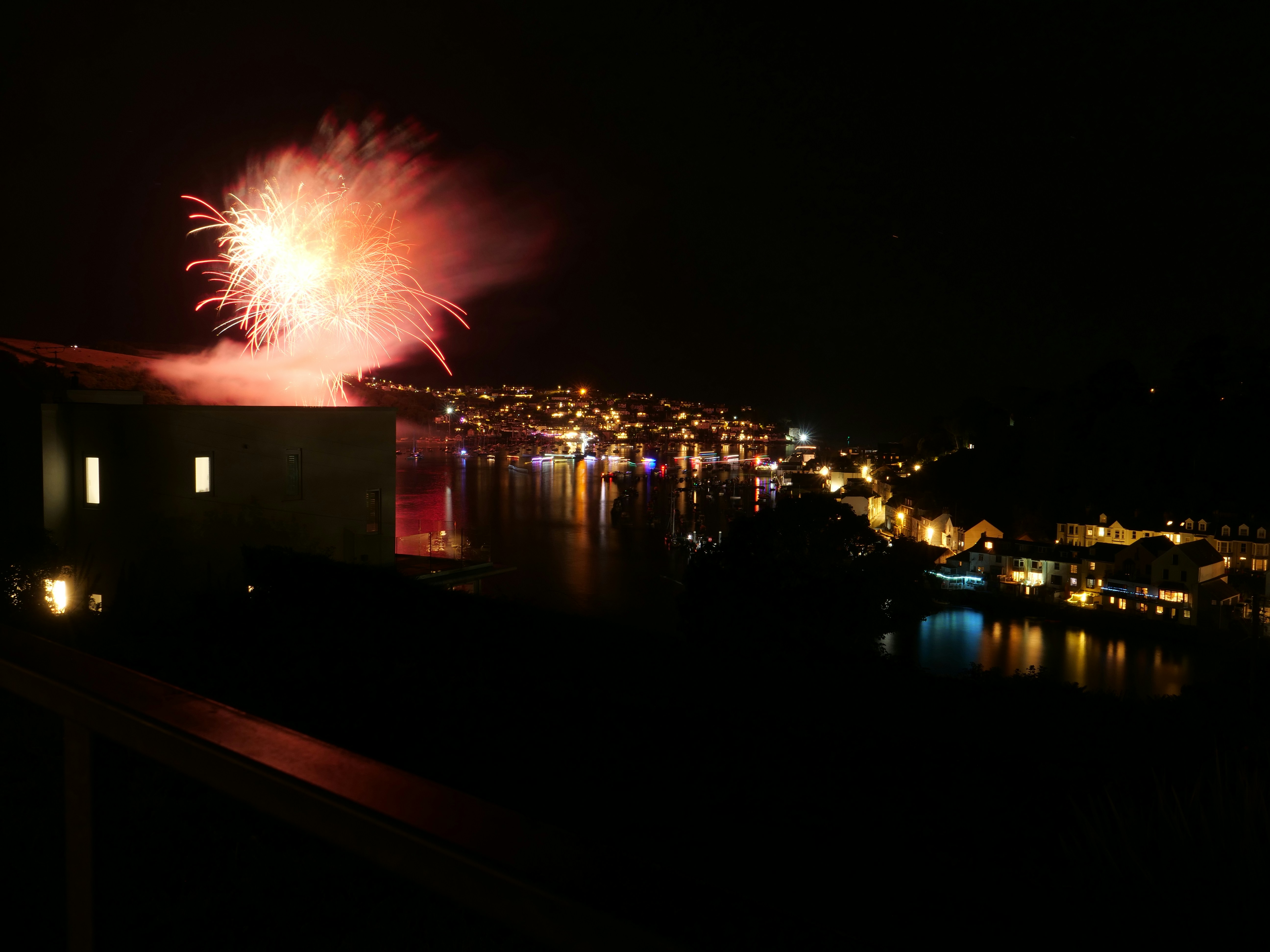 Firework Crest Over a Quiet Coastal Town
