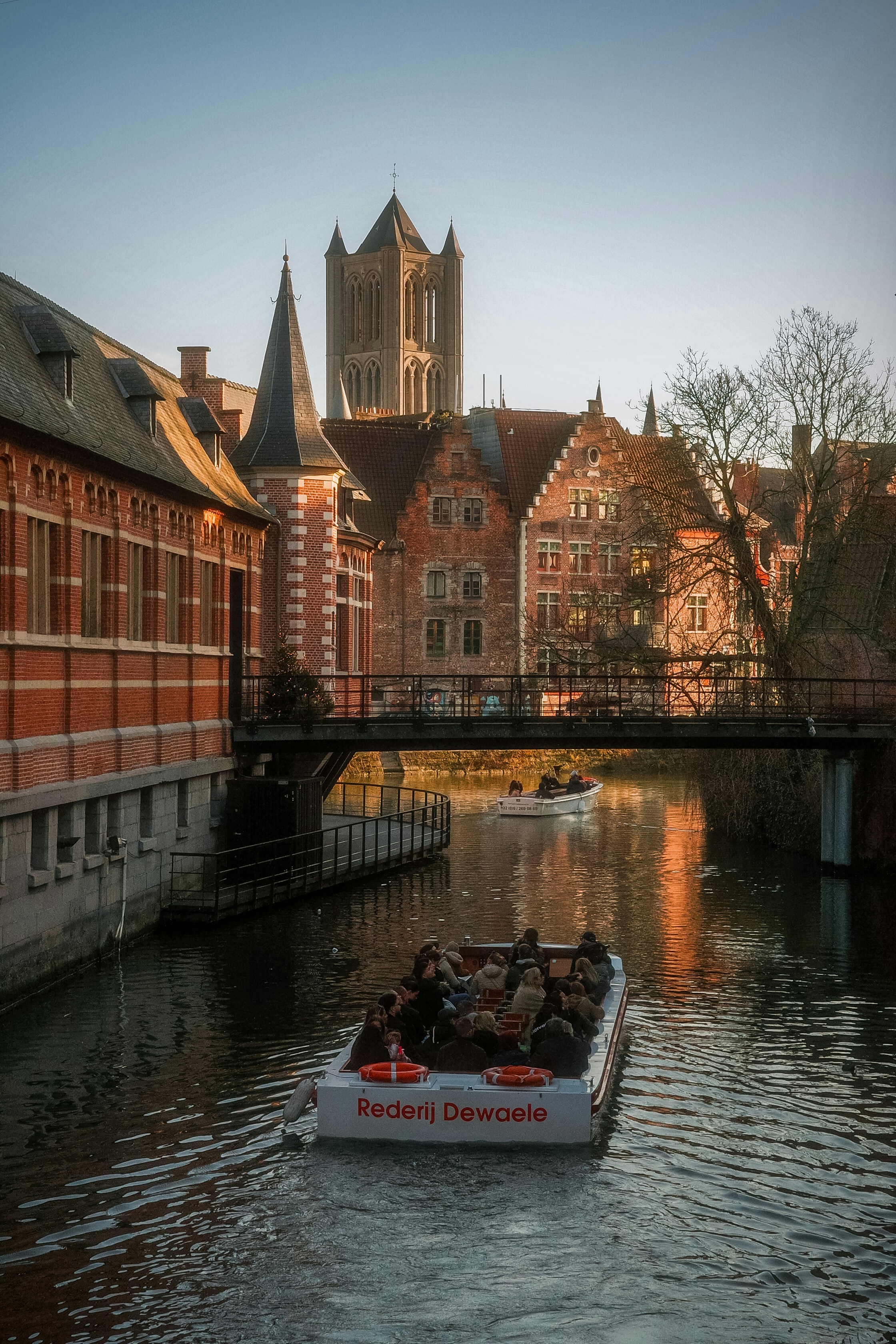 Boats on a canal with historic buildings and a tower. photo – Free ...