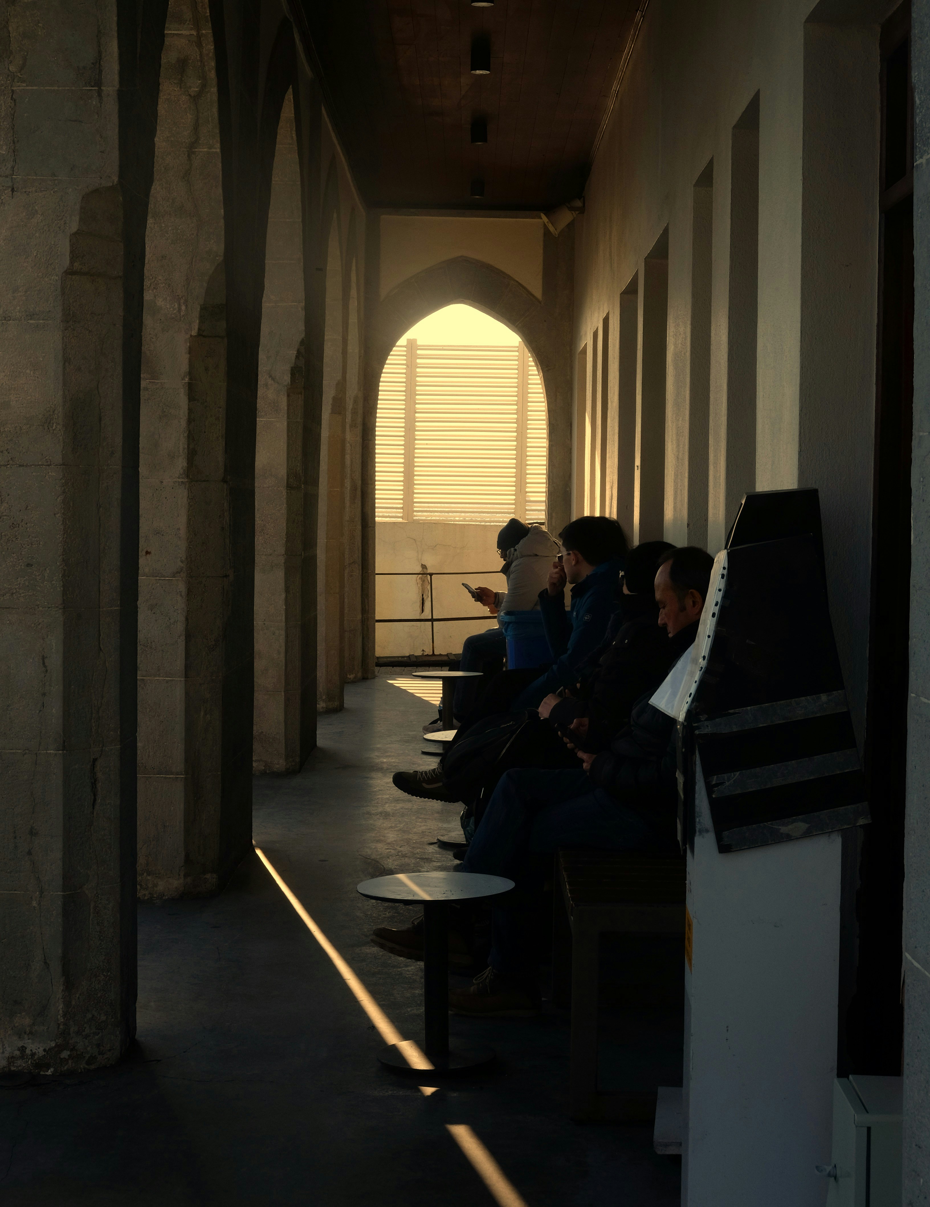 Shadows of a Corridor: Quiet Pause Along the Archway