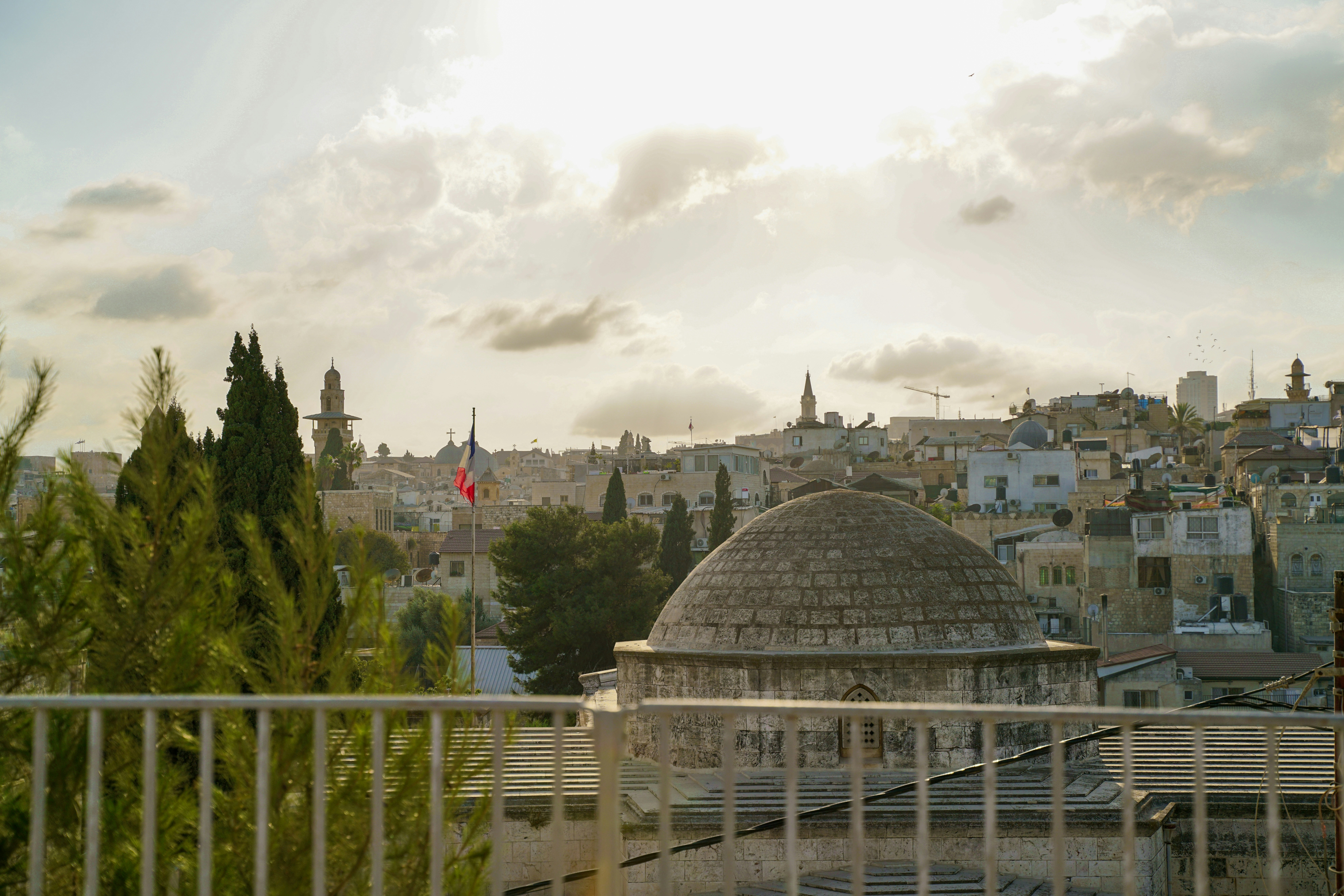 Rooftop overlook over a sunlit hillside city dome