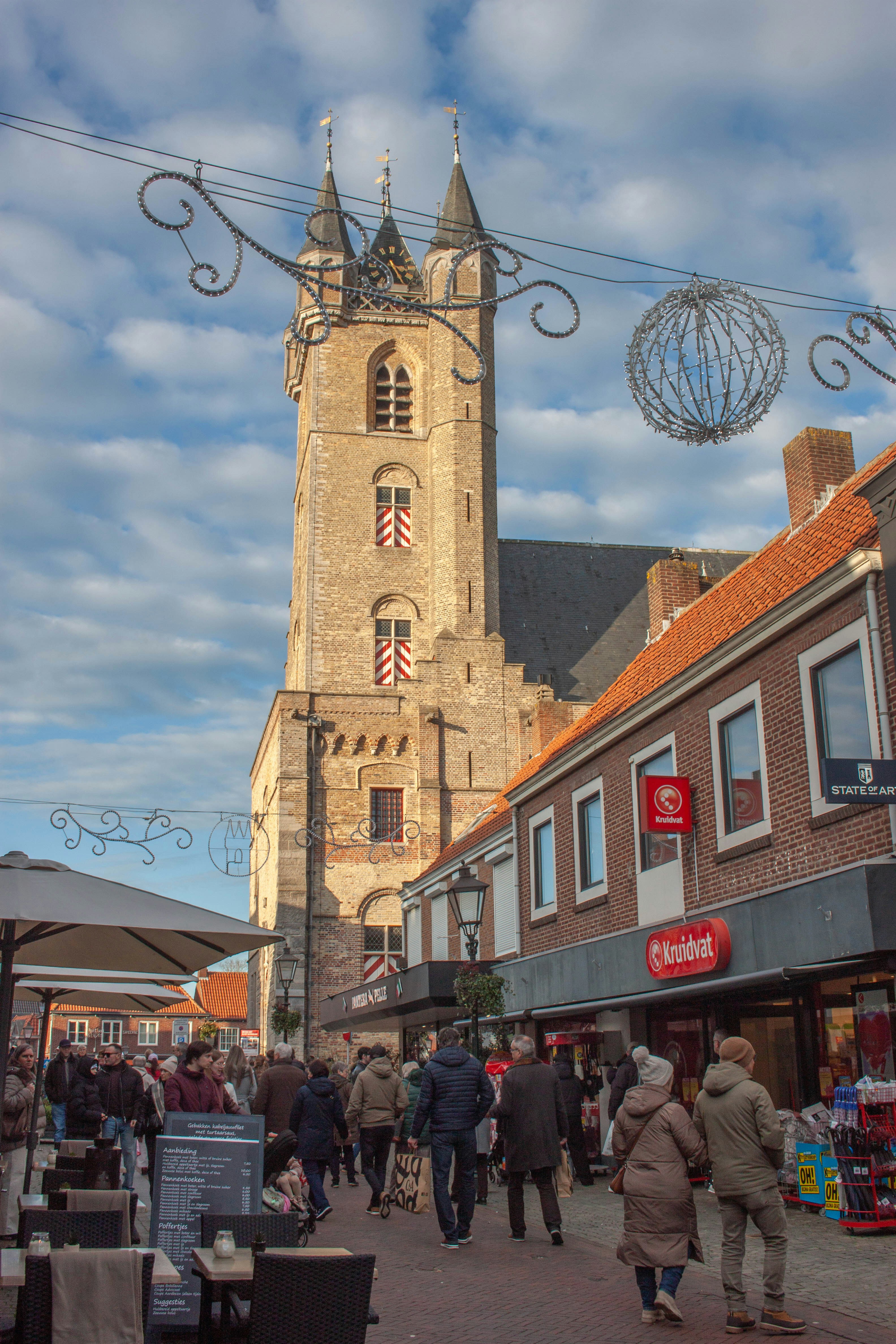 Tower Clock in the Market: A Festive Street Scene Under Ornamented Sky