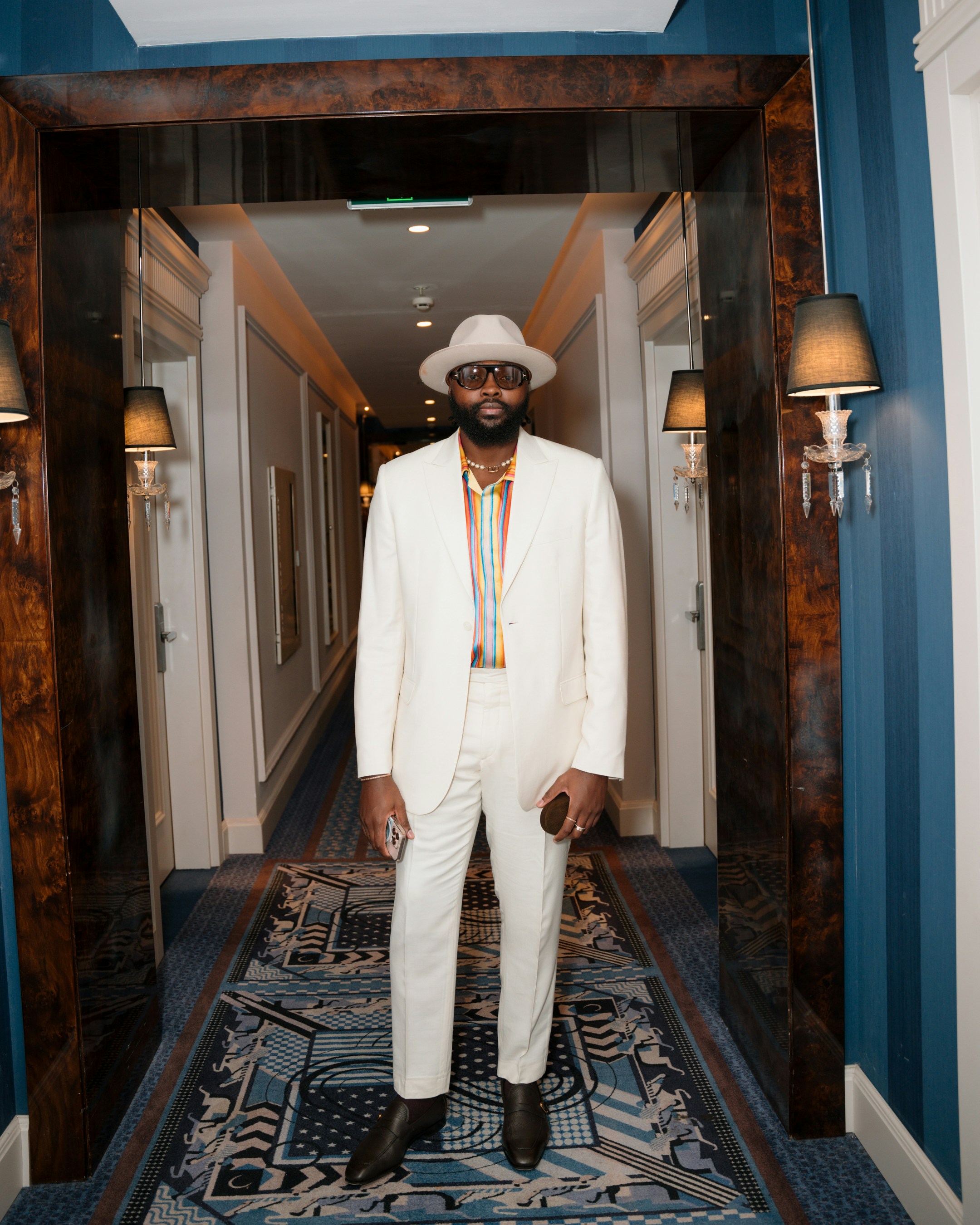 White Suit in a Pearl-Hued Corridor