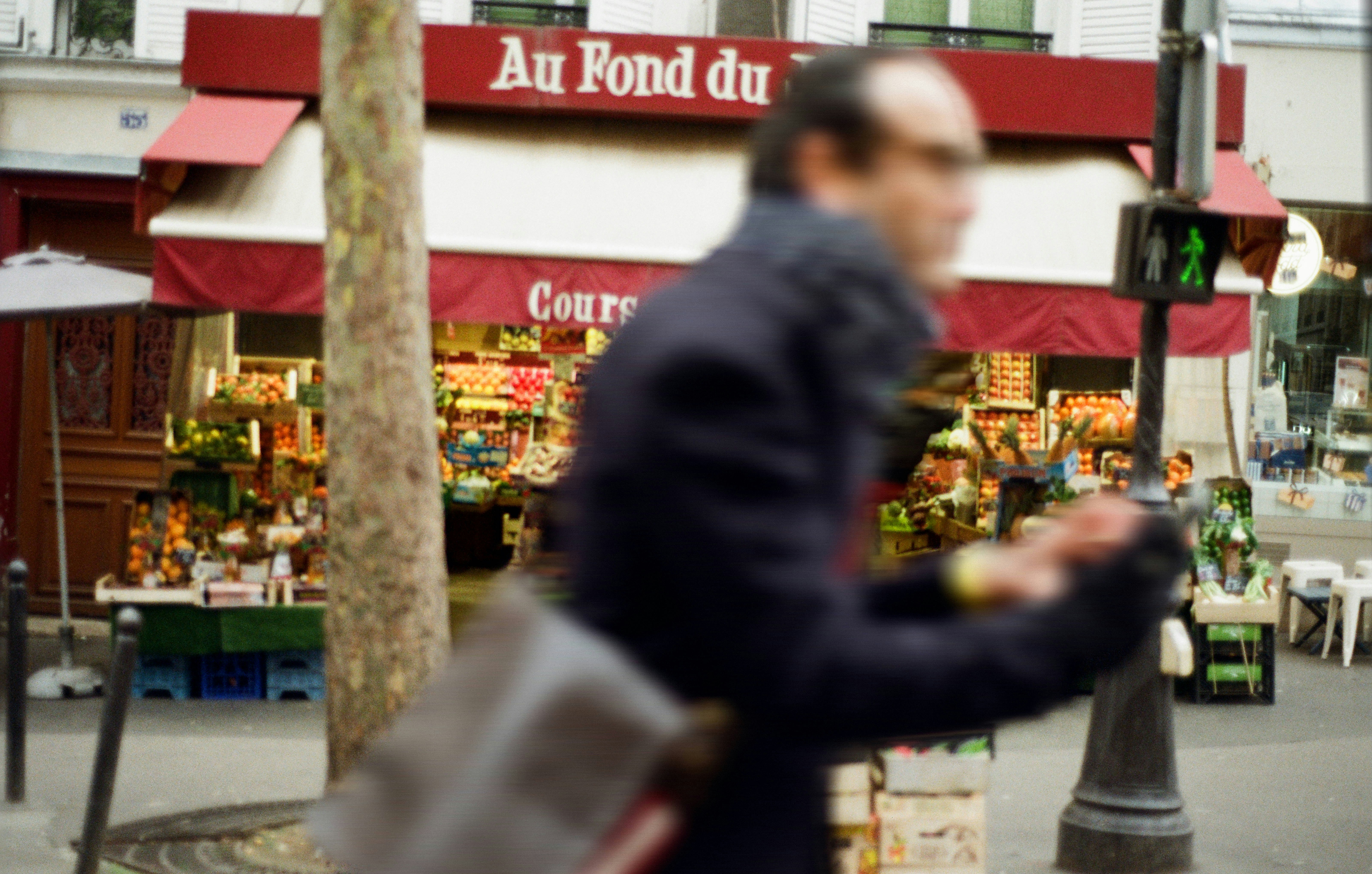 Man walking past a storefront in paris photo – Free Portrait Image on ...
