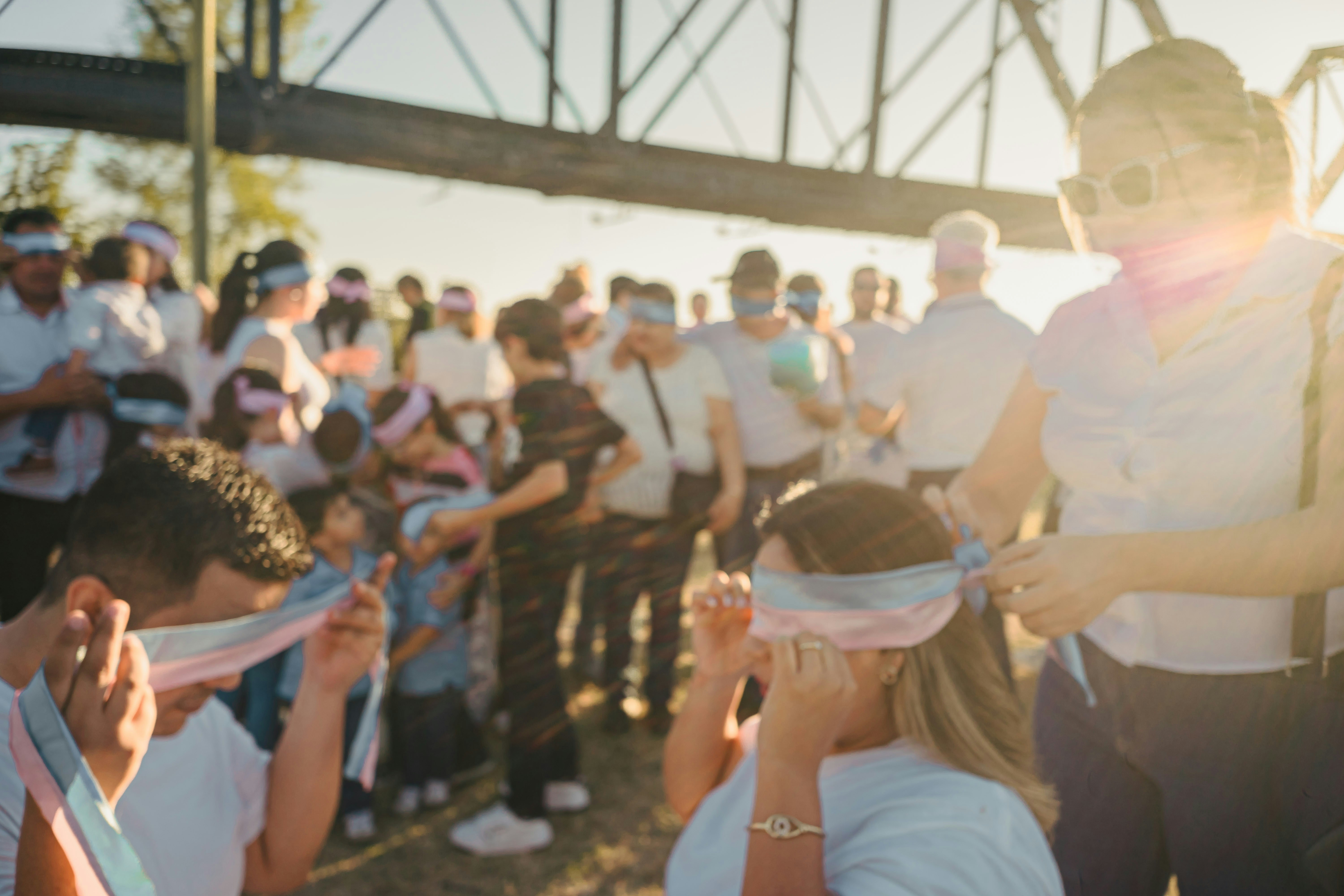 Blindfolded Circle: A Moment of Silent Unity Under a Sunlit Bridge