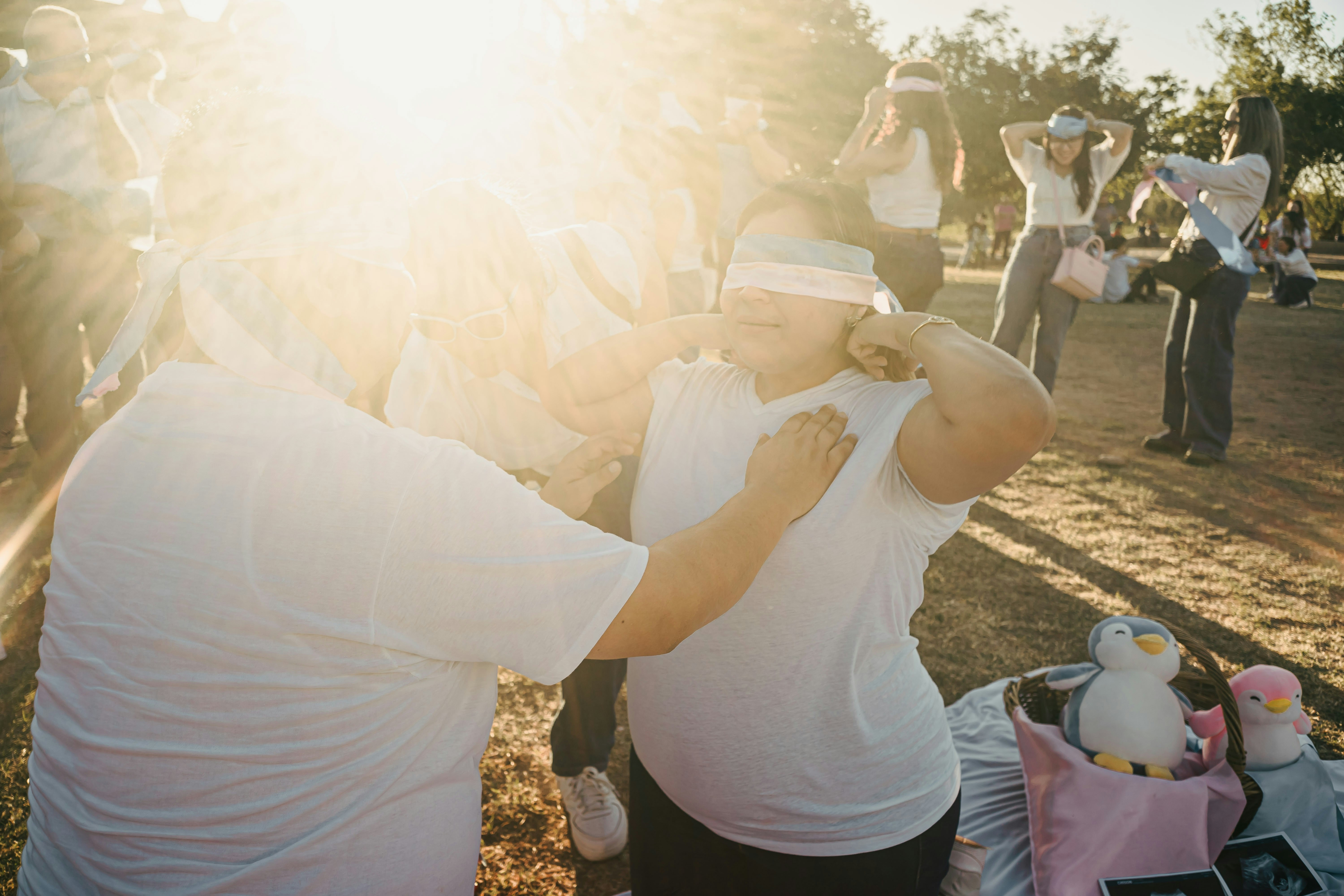 People playing a blindfolded game outdoors photo – Free Parents Image ...