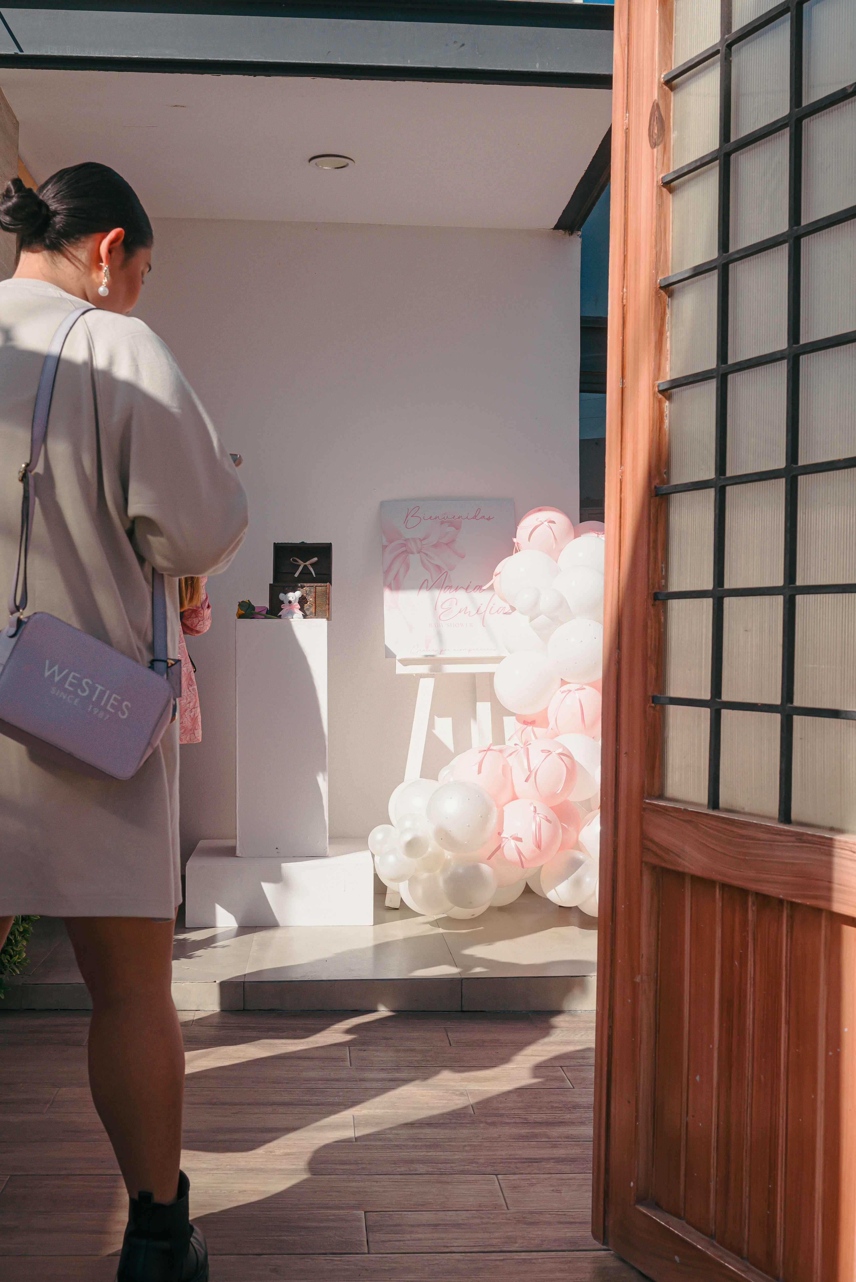 A Quiet Gallery Moment: Woman in Soft Beige Overcoat at the Doorway
