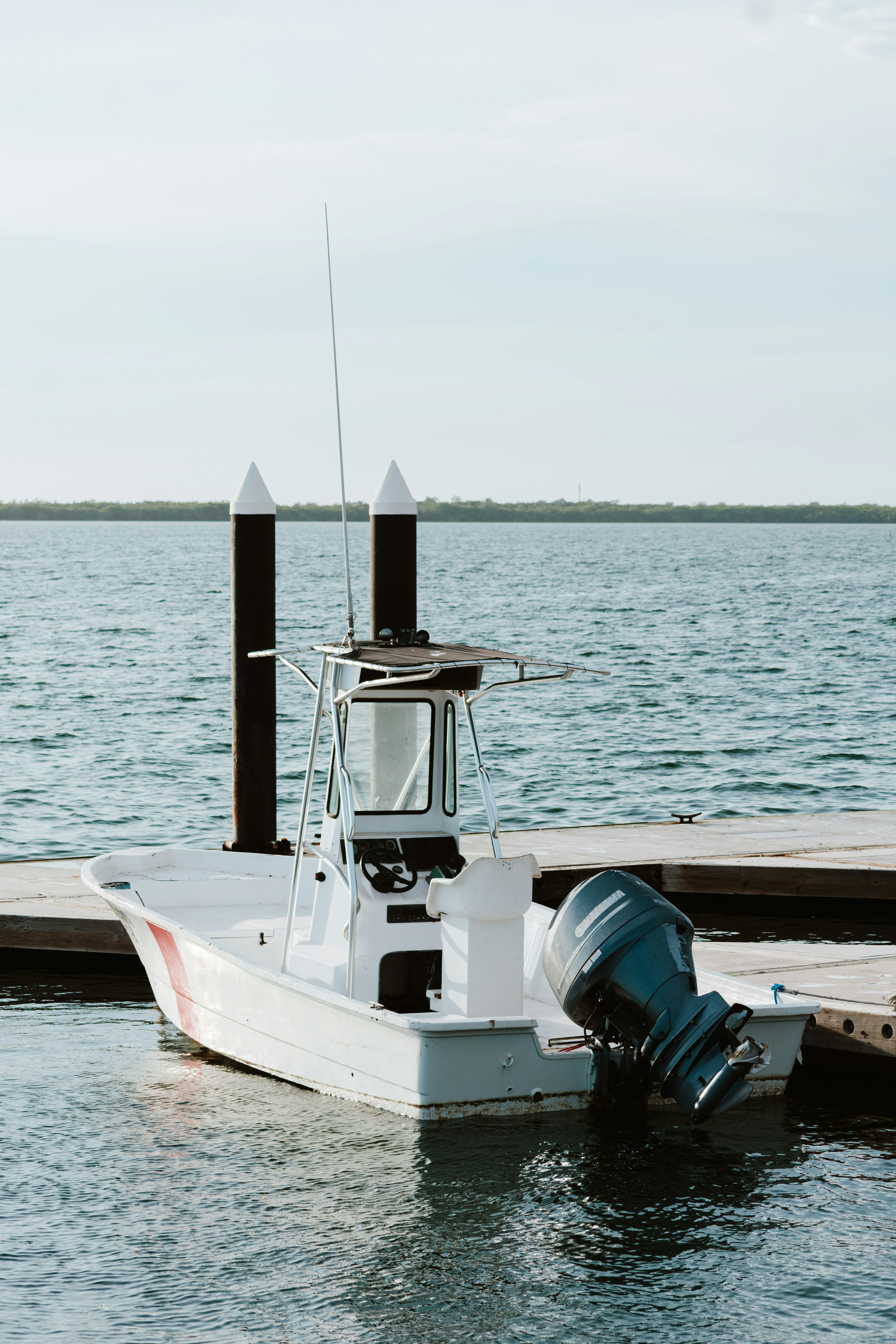 Boat at the Dock: Quiet Horizon and Sailing Craft