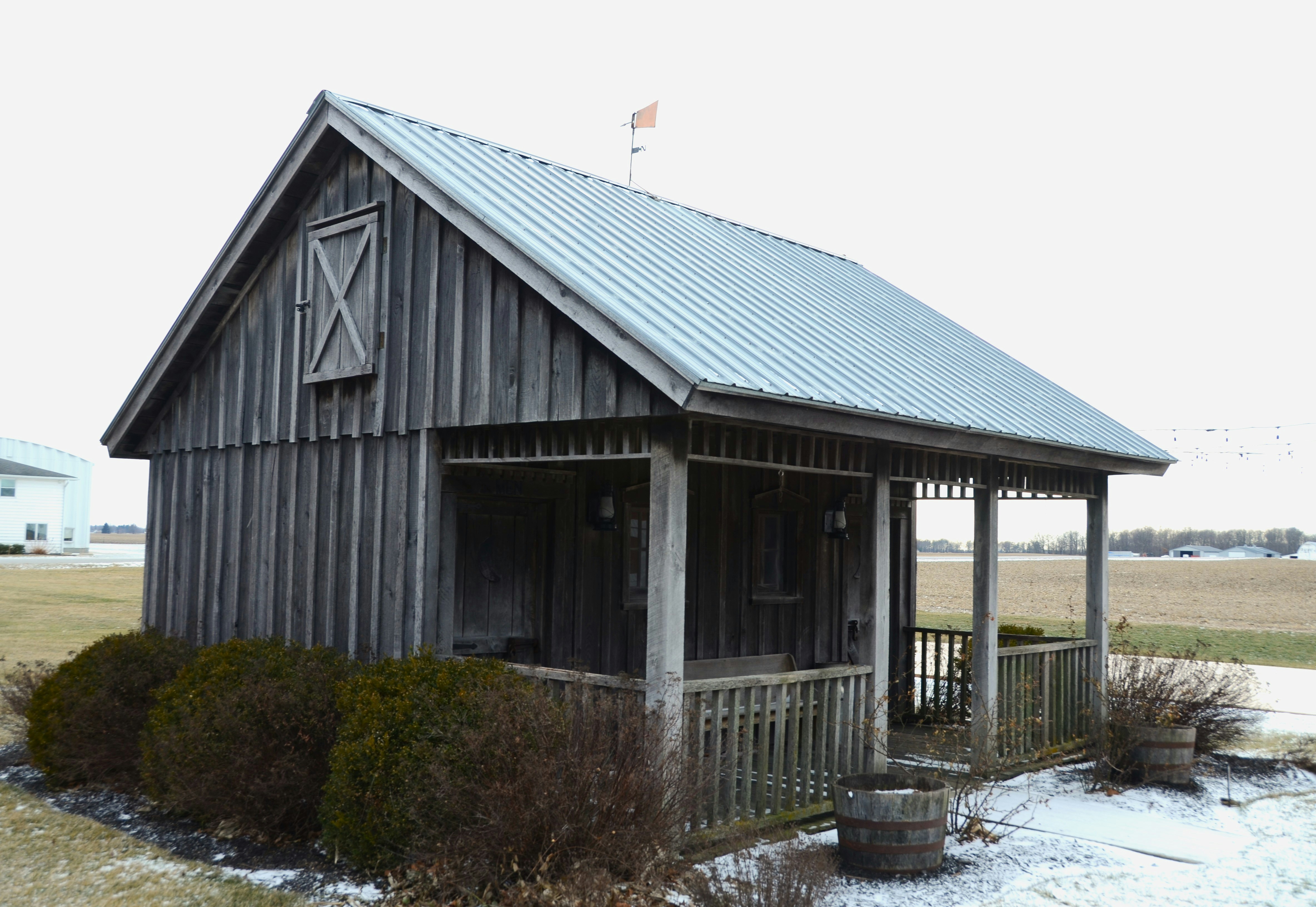 Weathered Barn Keeping Its Quiet Watch Over a Snow-dusted Field